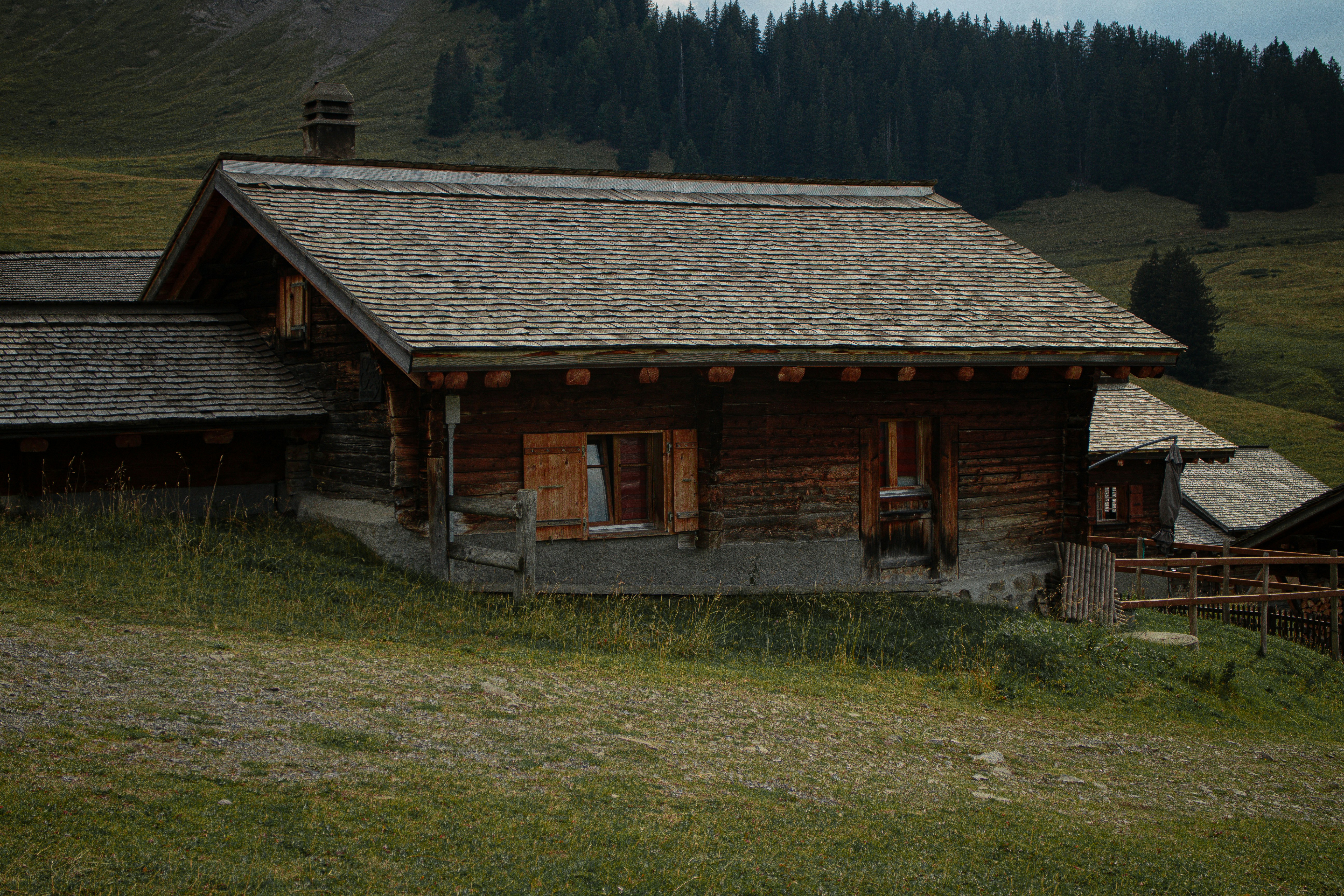 Cabin in the hillside: weathered timber and quiet fields