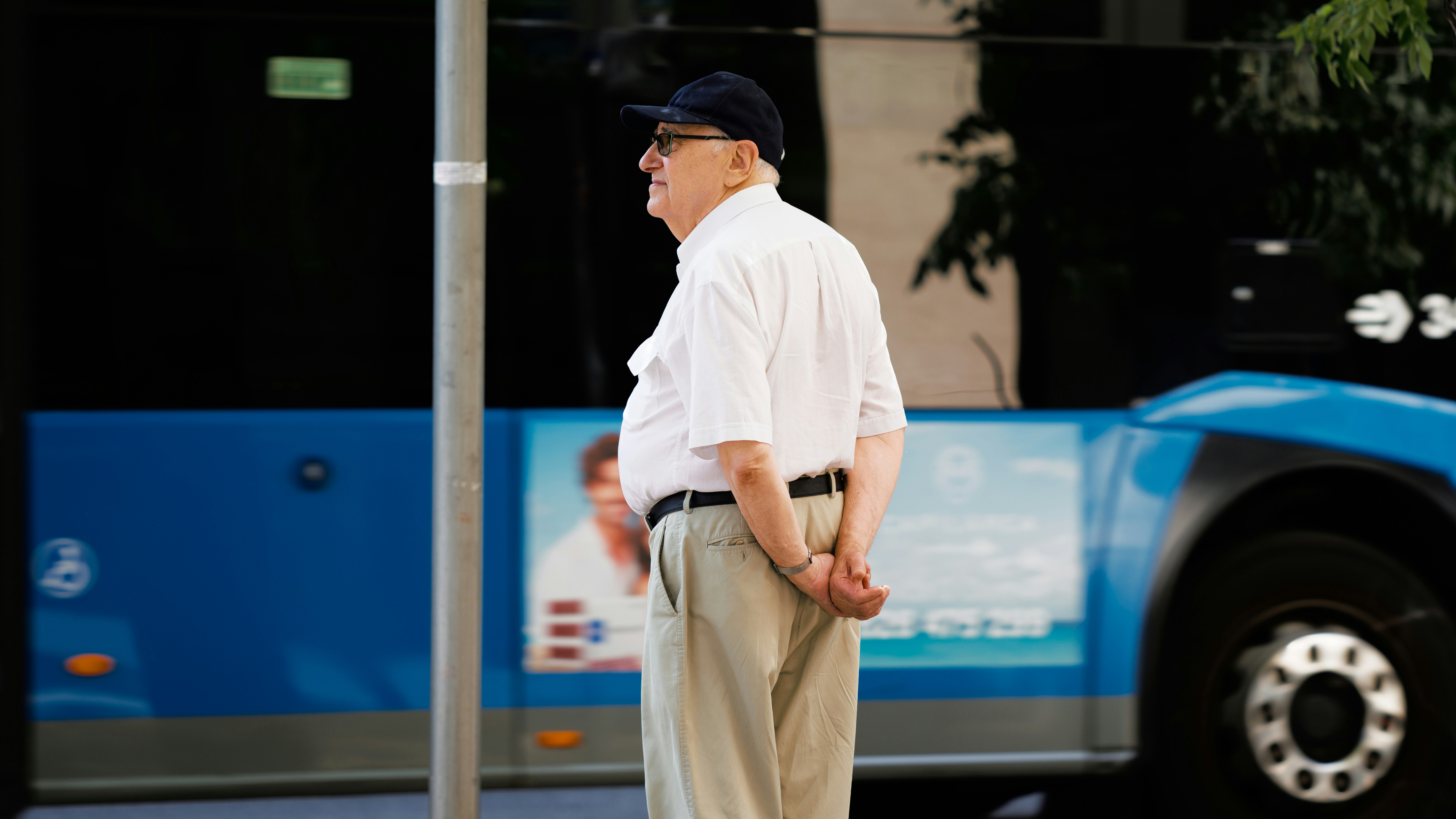 Urban Commuter in Profile: A Quiet Moment Beside the Bus