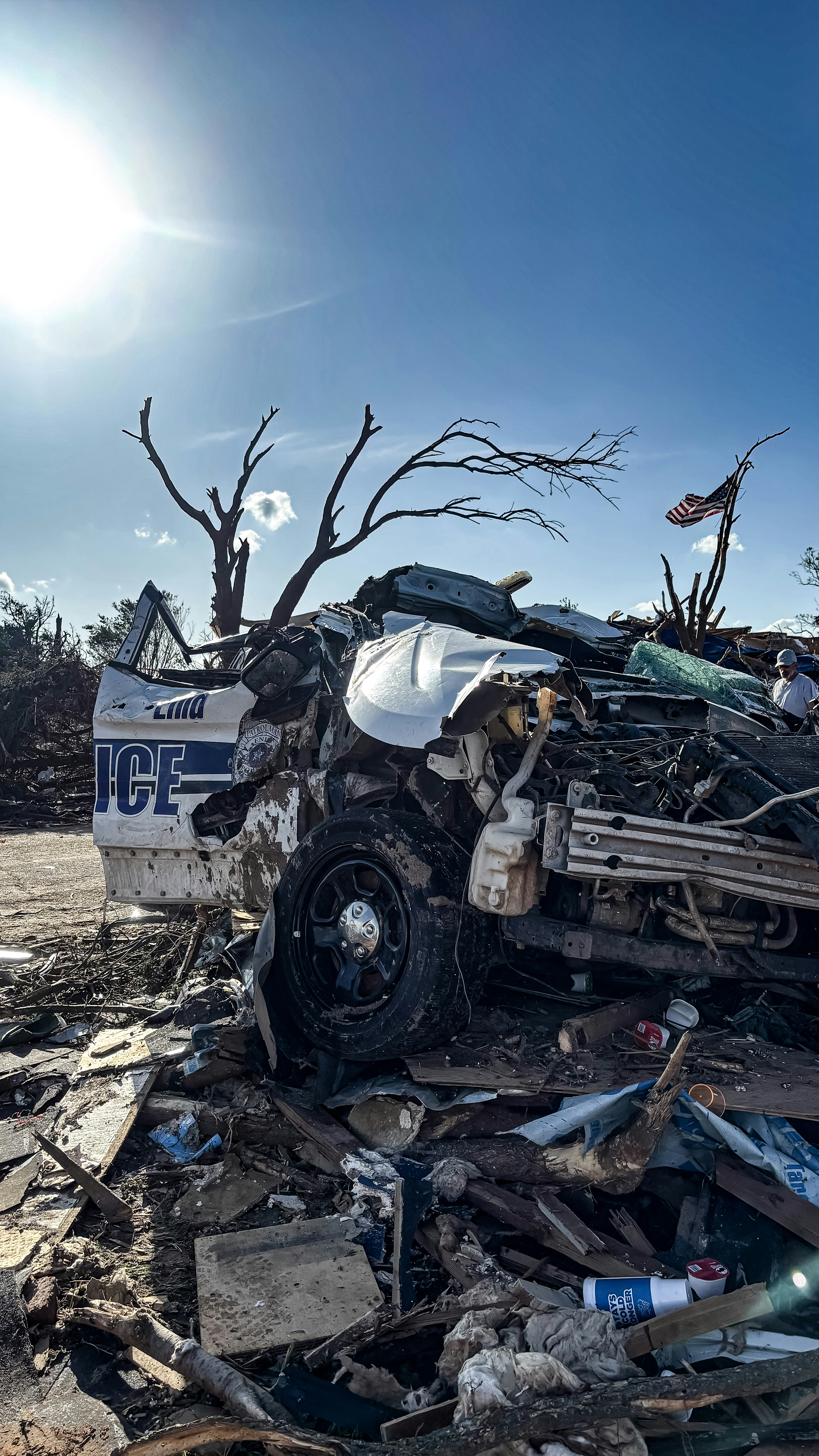 Rubble and Remains: A Crushed Patrol Vehicle Under a Widening Sky