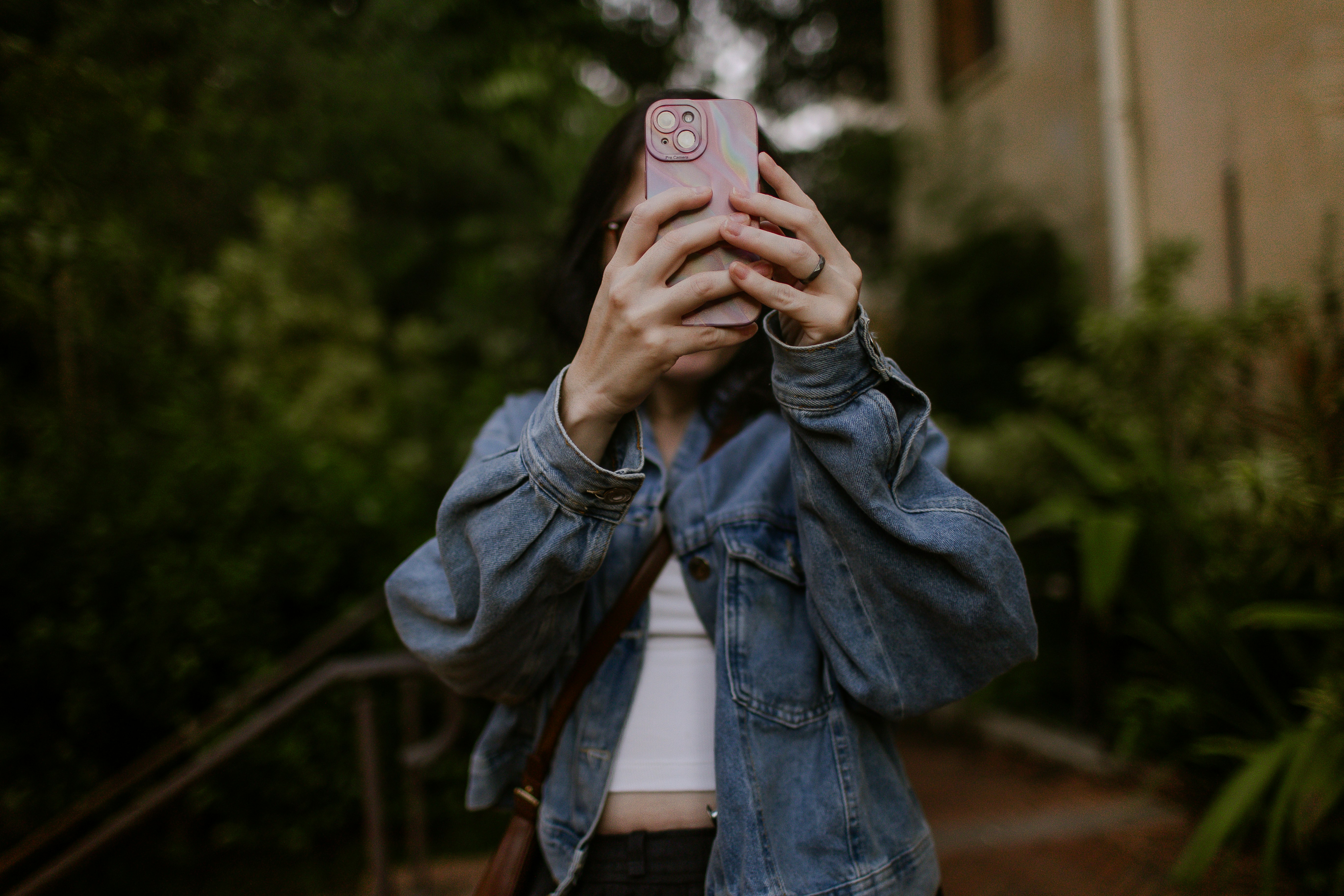Portrait in the Spotlight: Hands Up with a Pink Phone