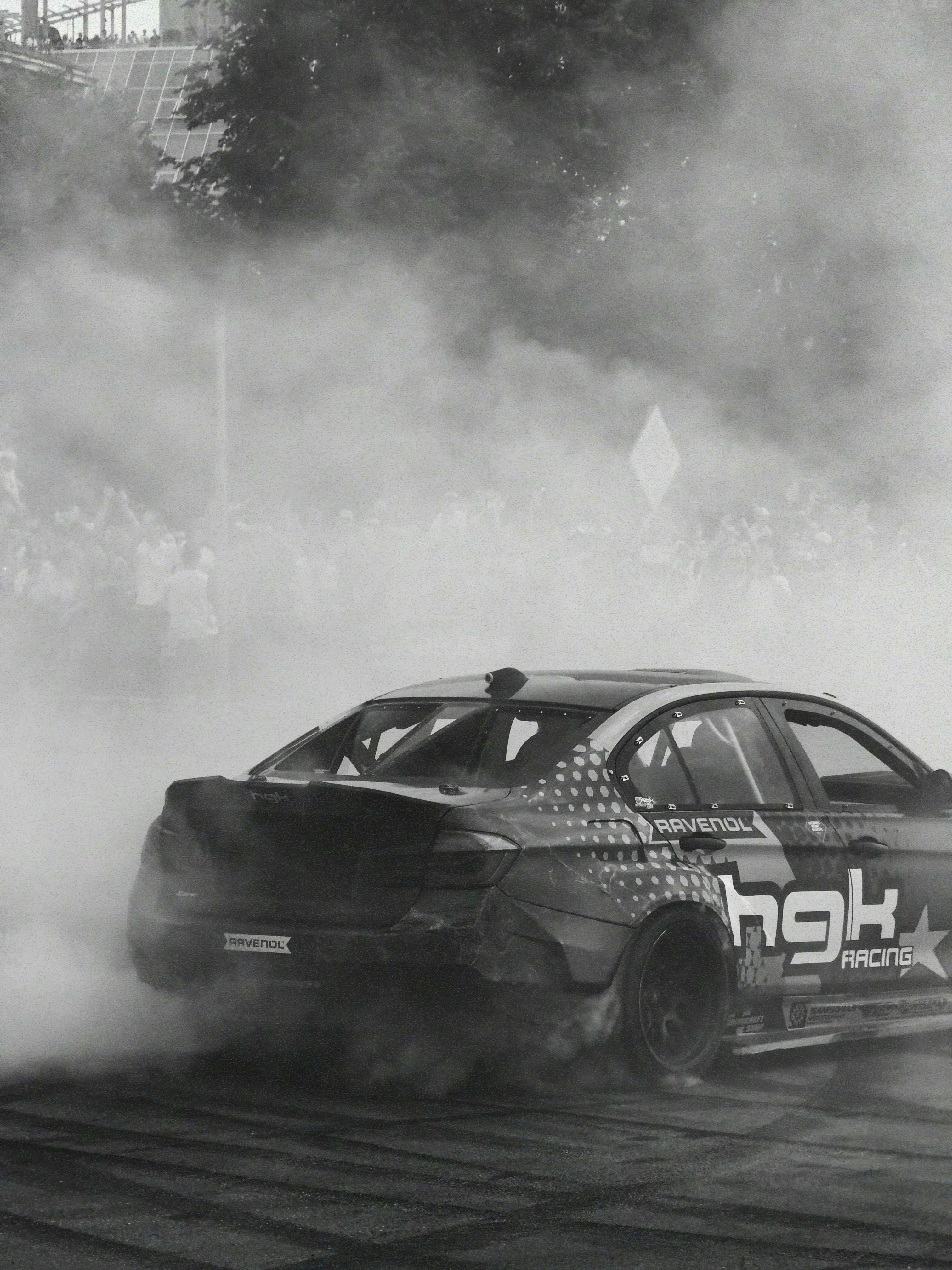 Racing in the Smoke: A Car Breaks Through the Drift