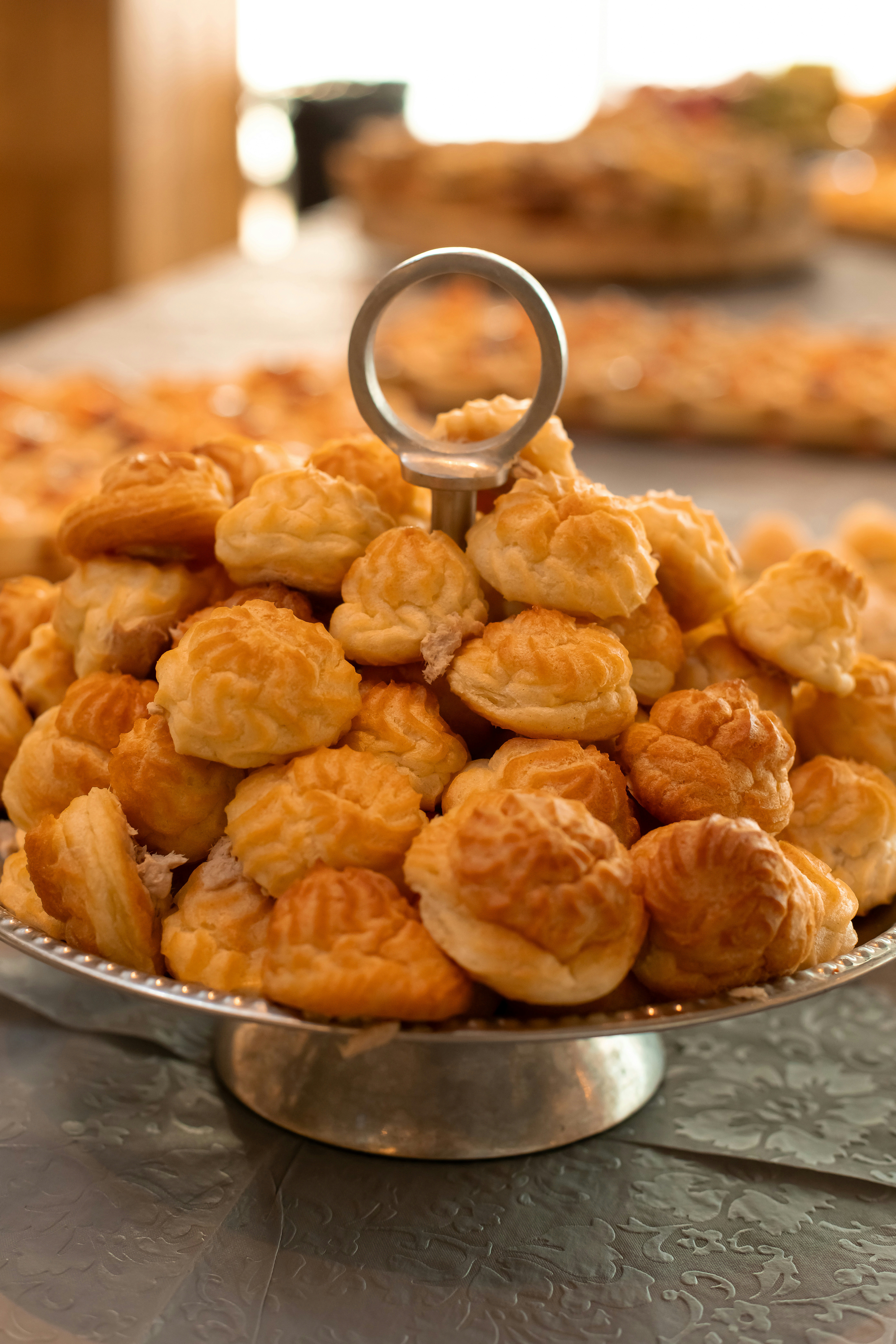 Golden Cream Puff Tower: A Carousel of Pastry on a Silver Stand