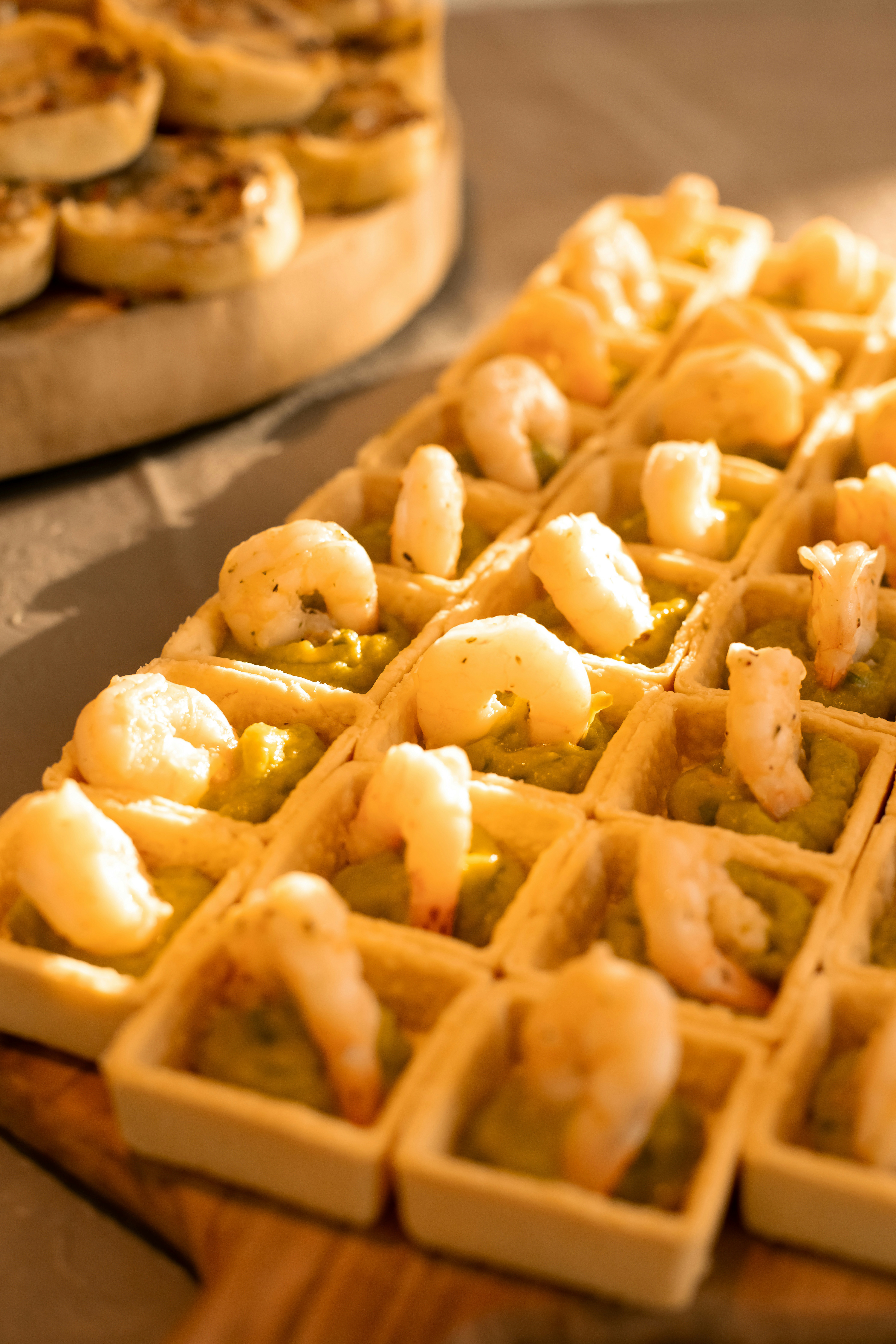 Shrimp-topped pastry bites: golden nibbles arranged in neat grids
