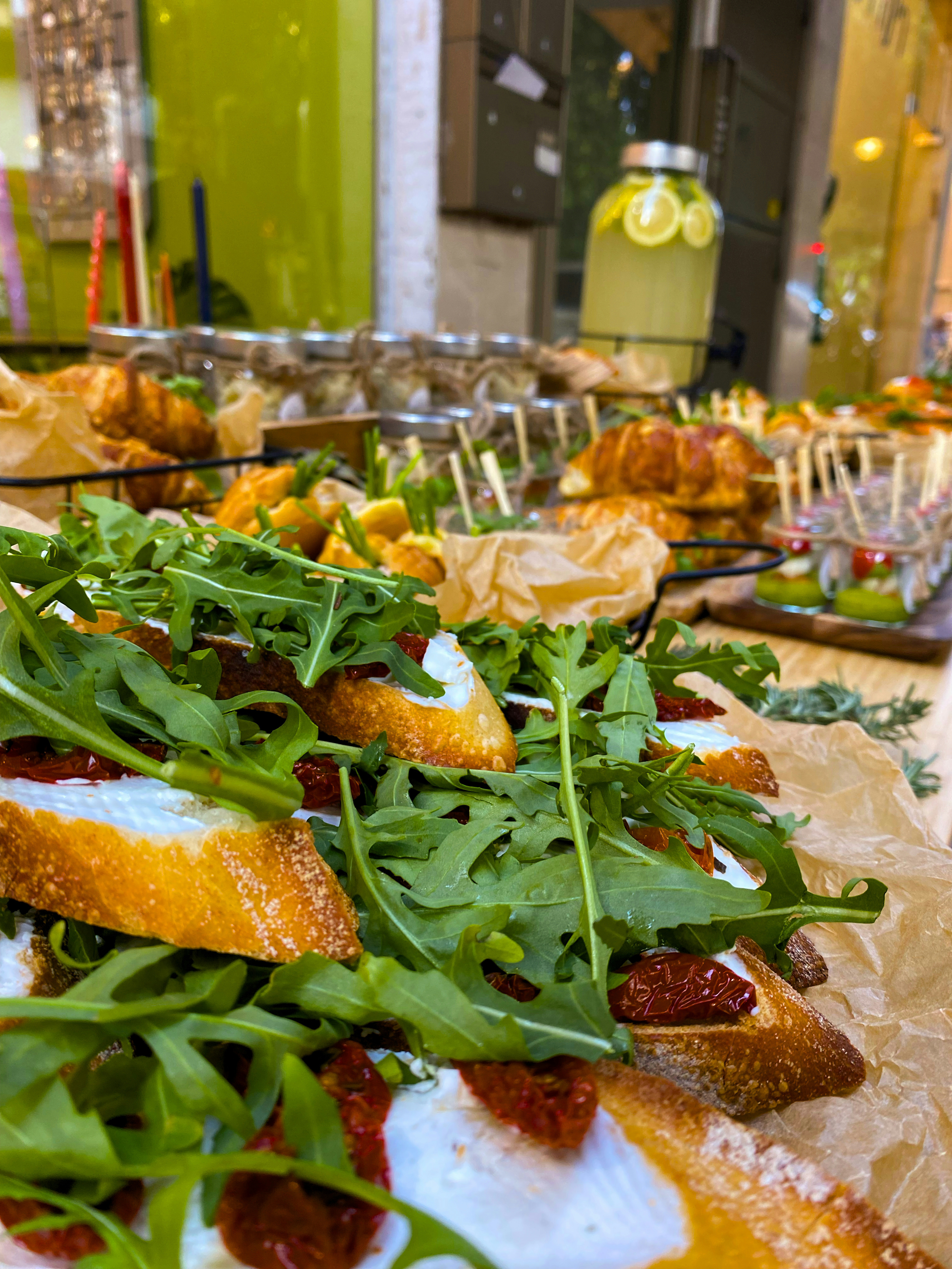 Arugula-Topped Bruschetta Parade in a Bright Café Display
