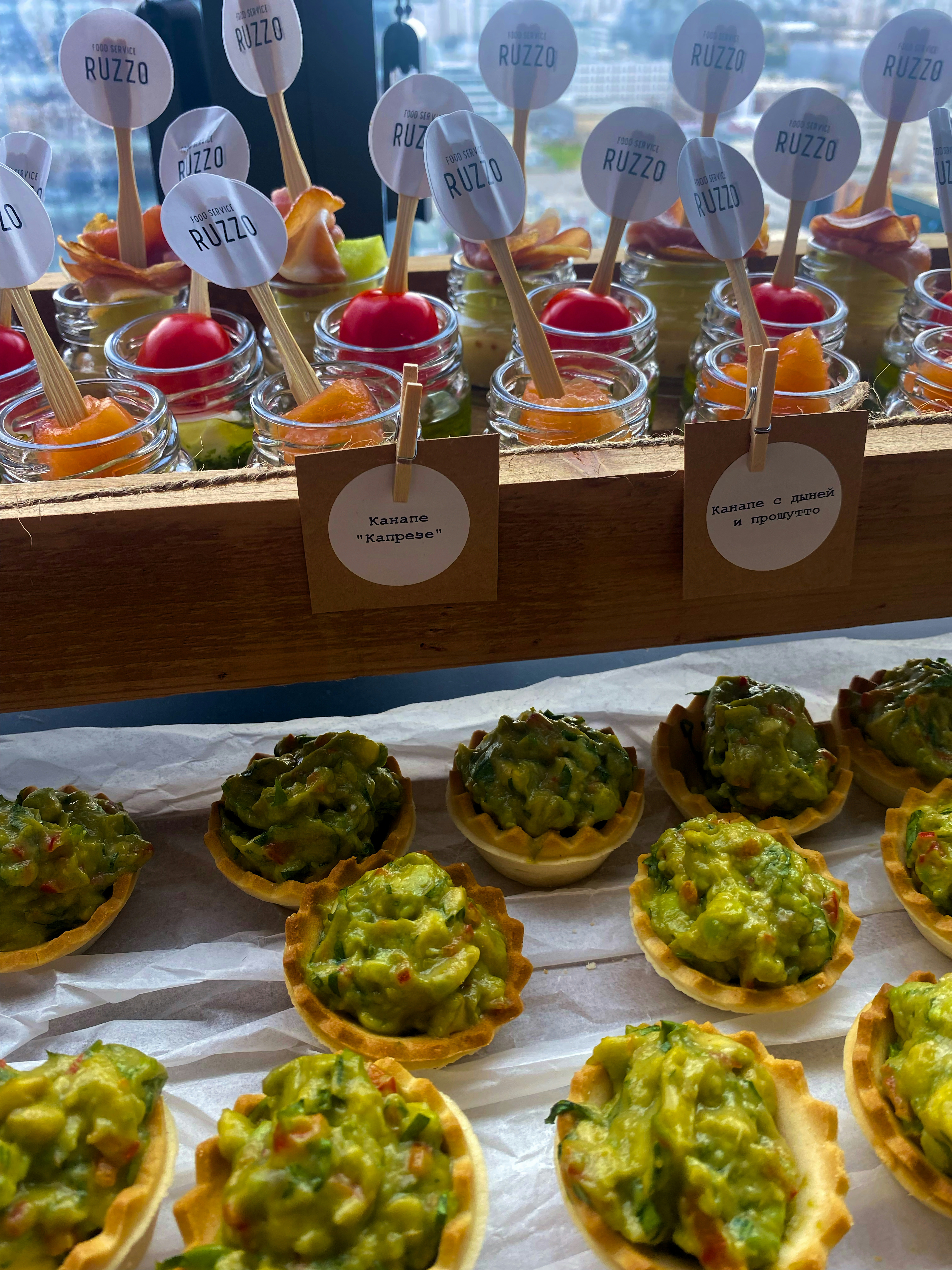 Gourmet Pastry Tasting: Avocado Tartlets Under a Tag-Lined Display