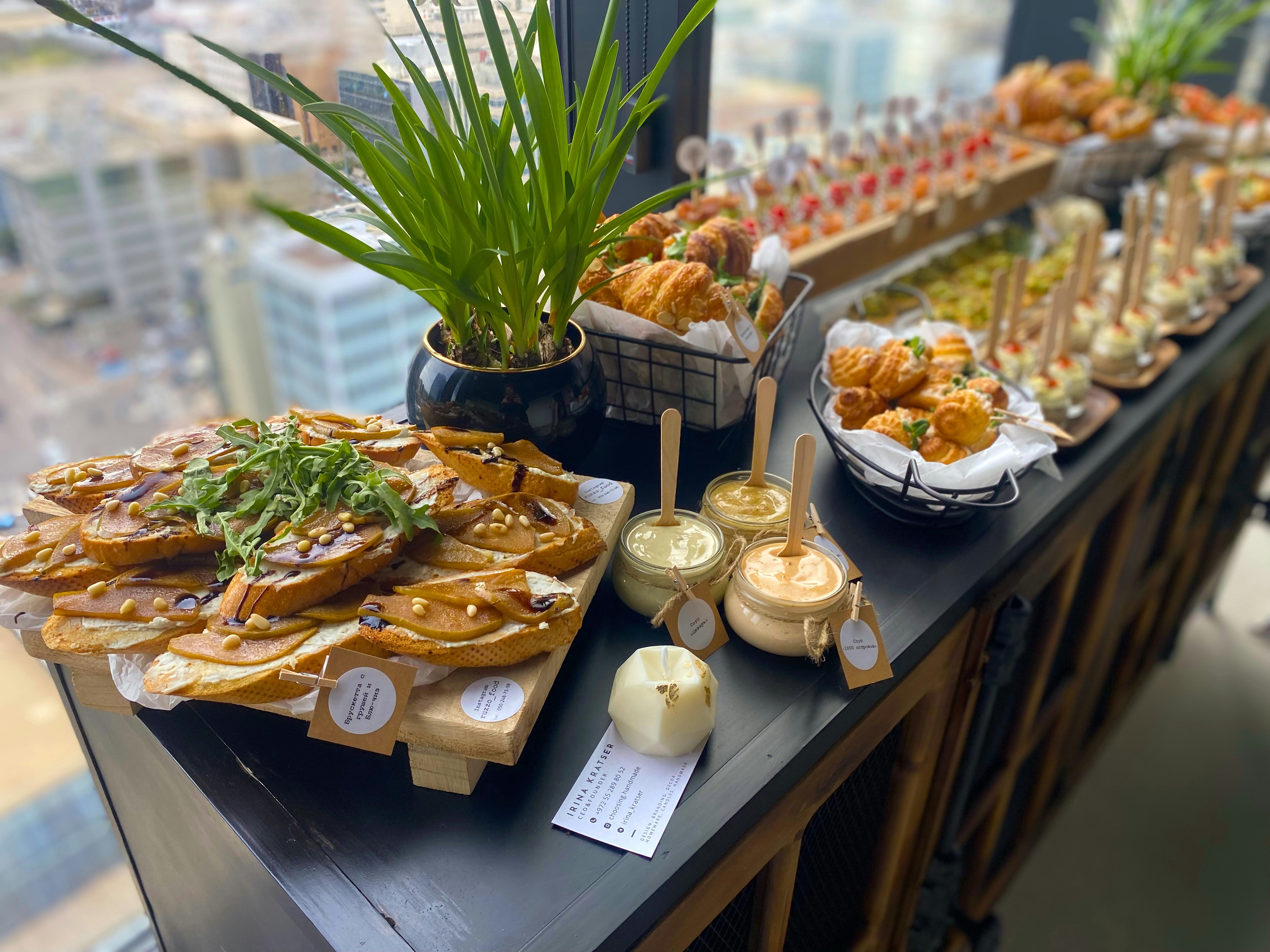 A Lineup of Gourmet Canapés and Pastries Cascading Along a Dinner Table