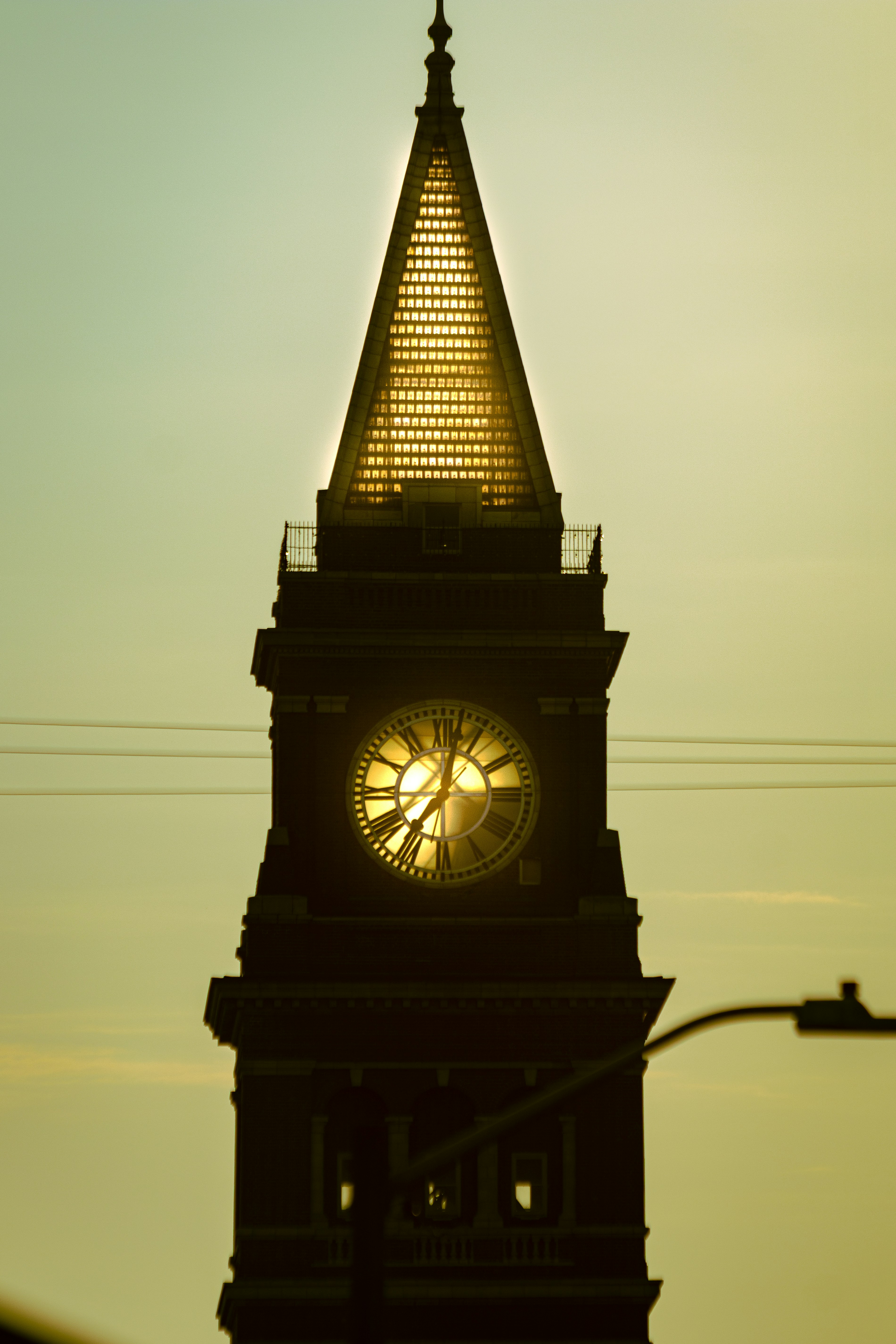 Timekeeper at Dusk: A Clocktower Piercing the Golden Sky