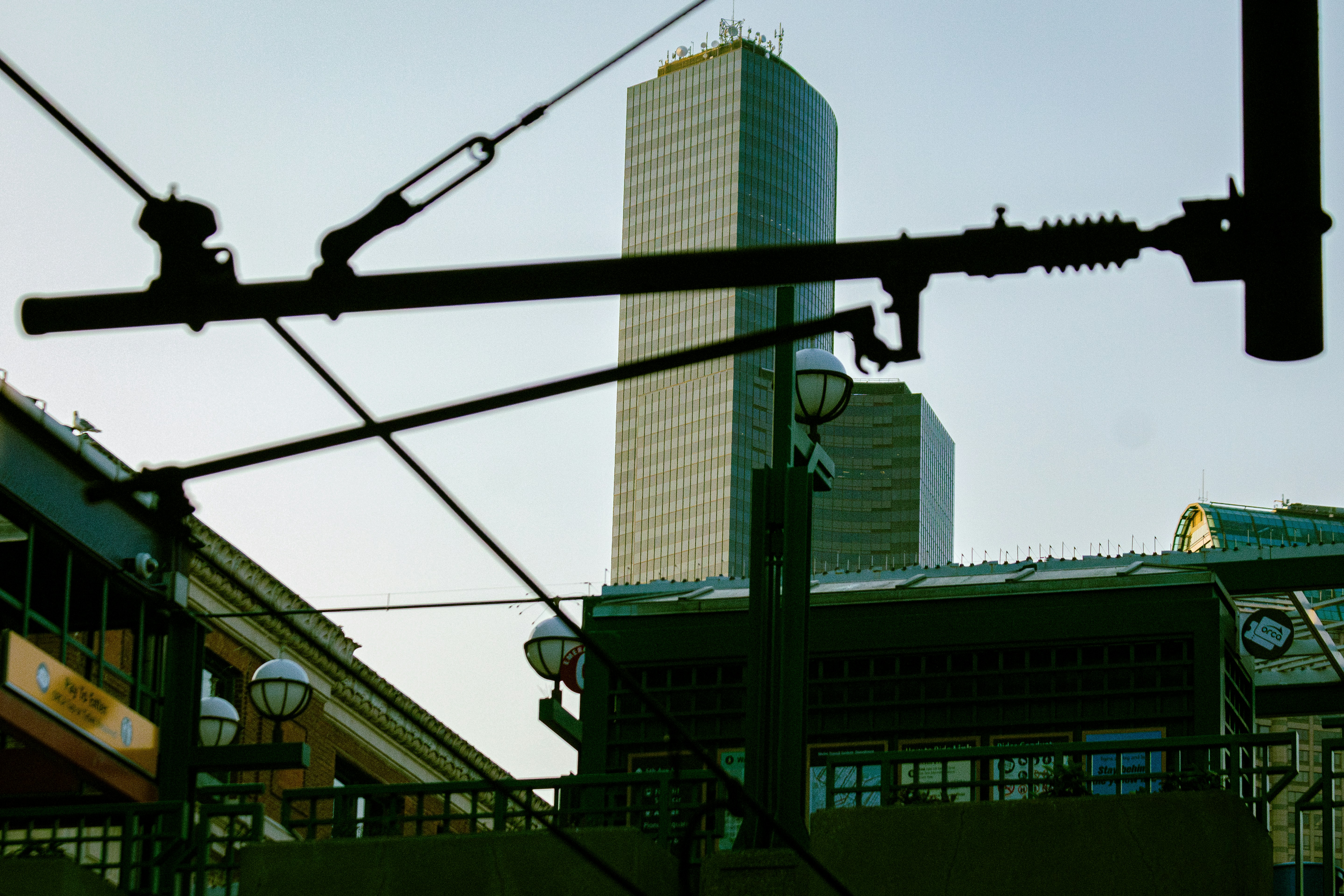 Urban Skyline Framed by Trolley Wires