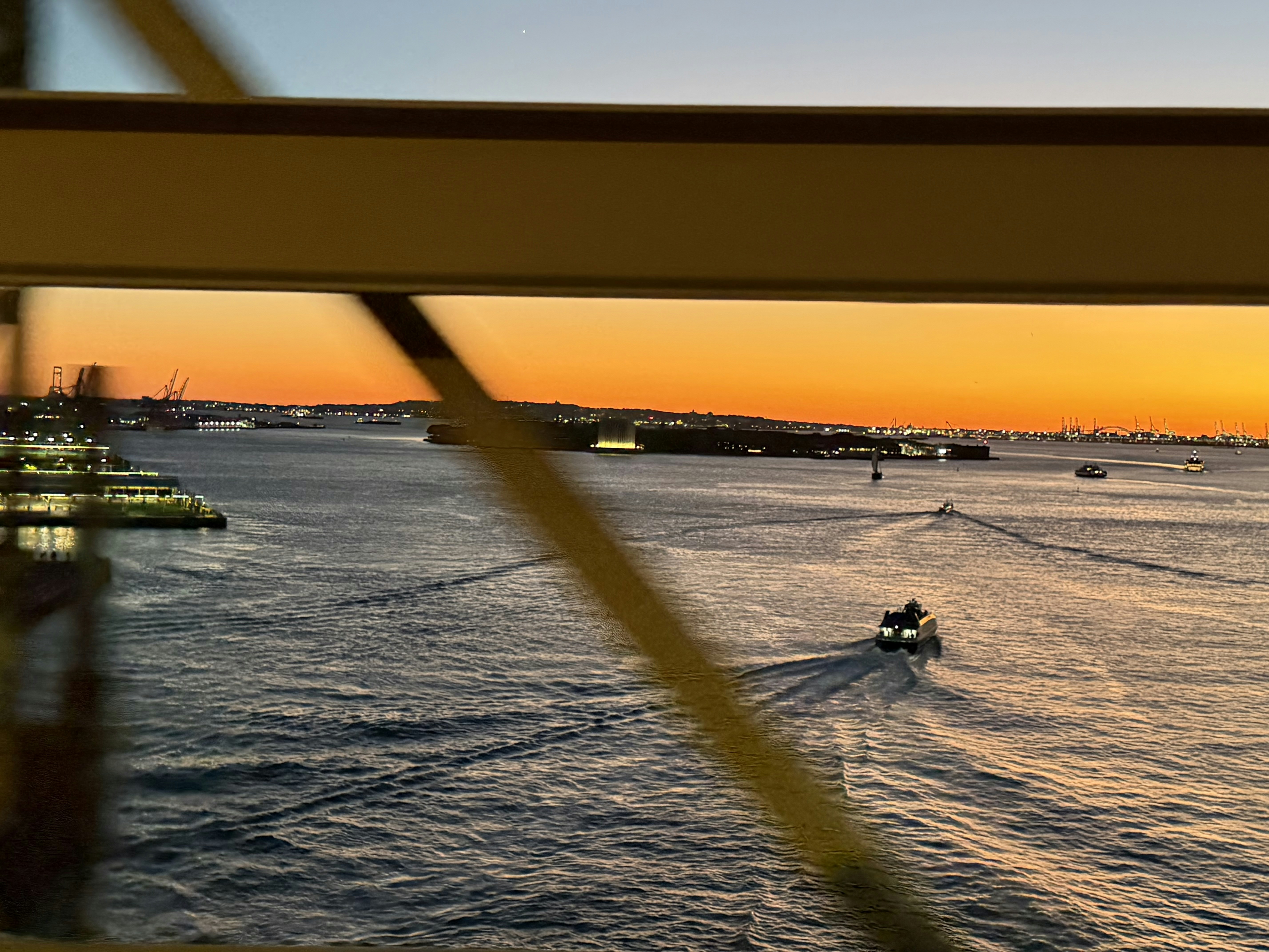 Sunset Passage: Boats on a Quiet Harbor Bordered by Golden Horizon