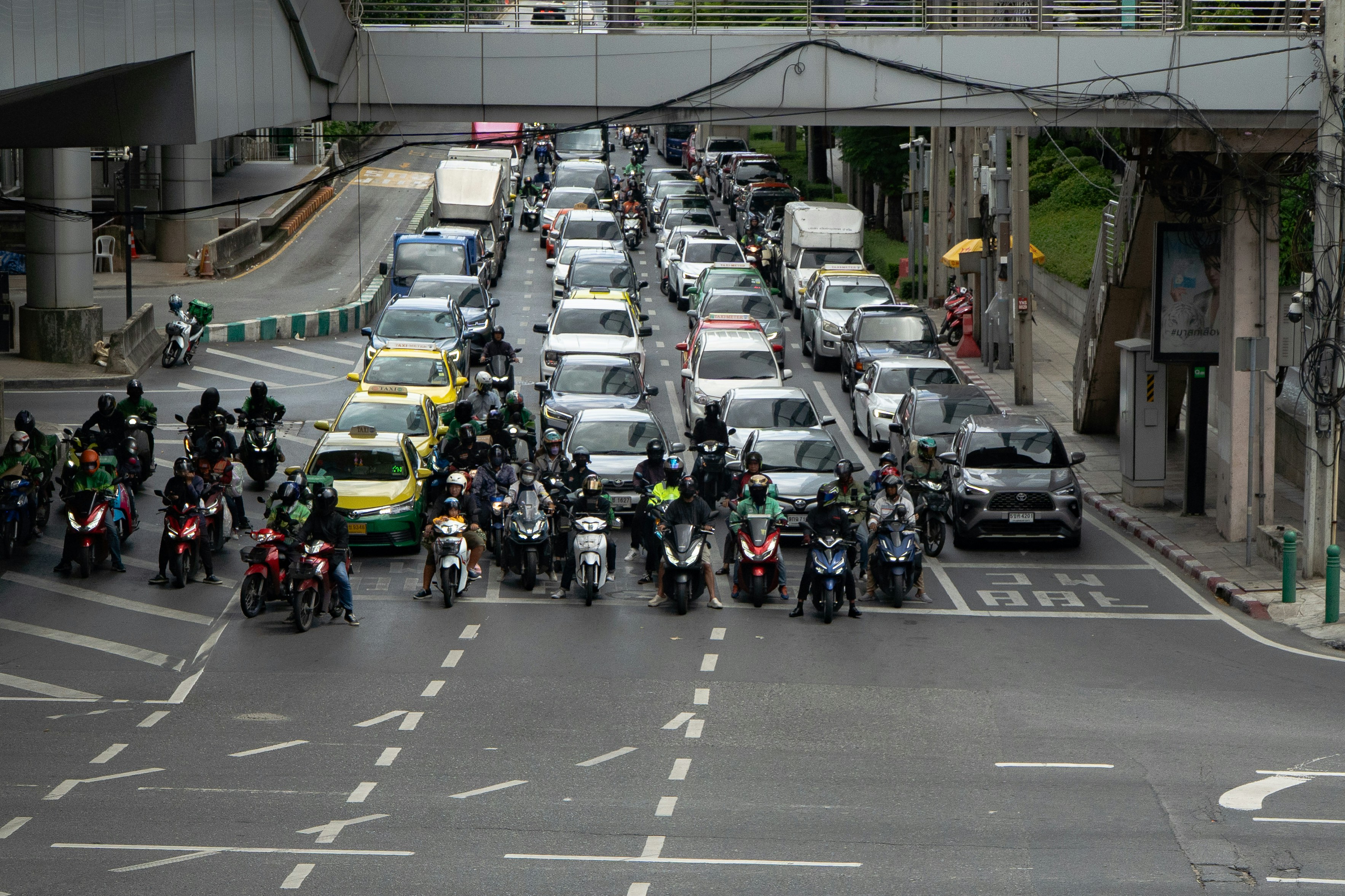 Crossing Wave: A Corridor of Cars and Motorcycles at a Busy Street Junction