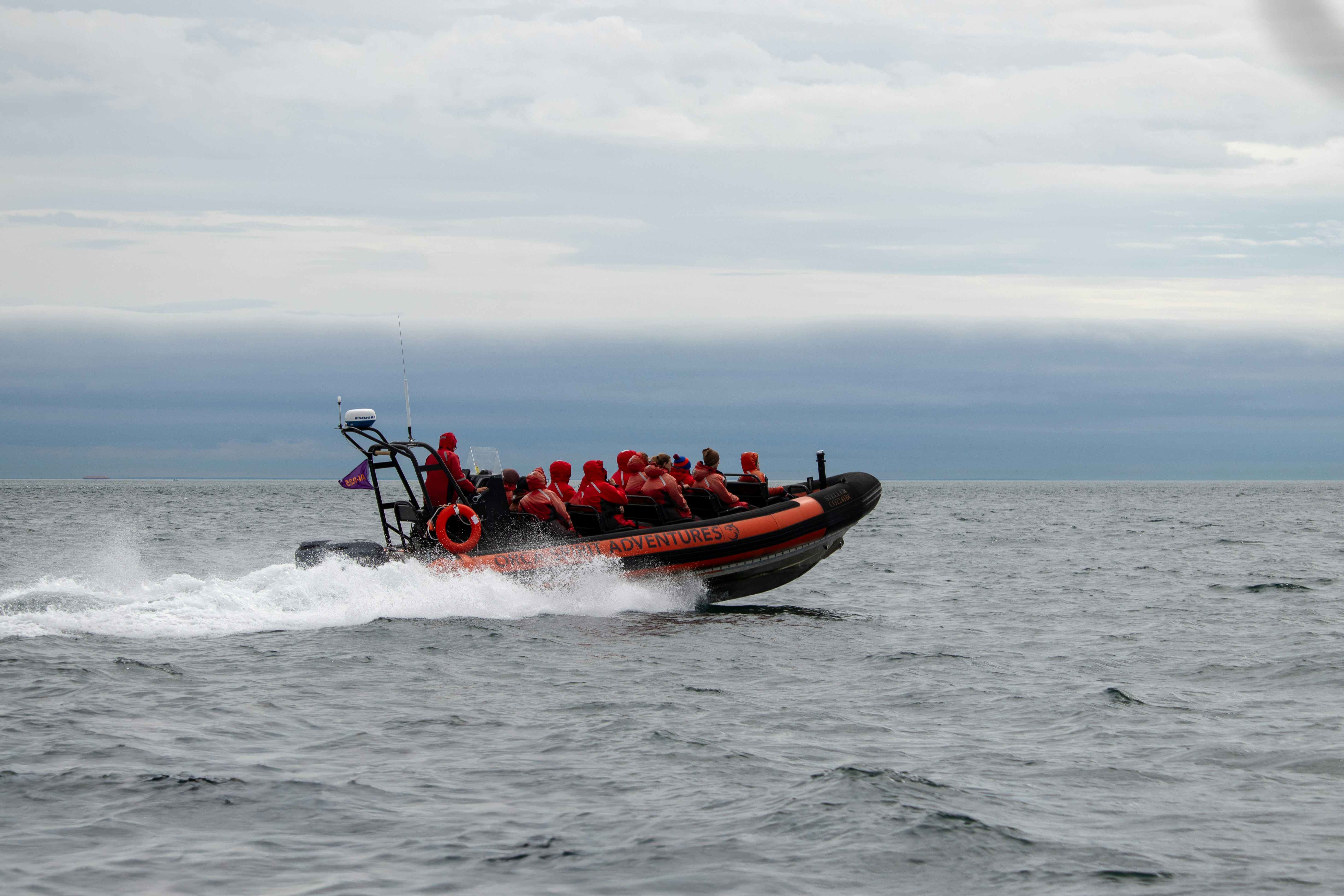 Life Raft in Motion: A Red-clad Crew Cutting Across the Sea