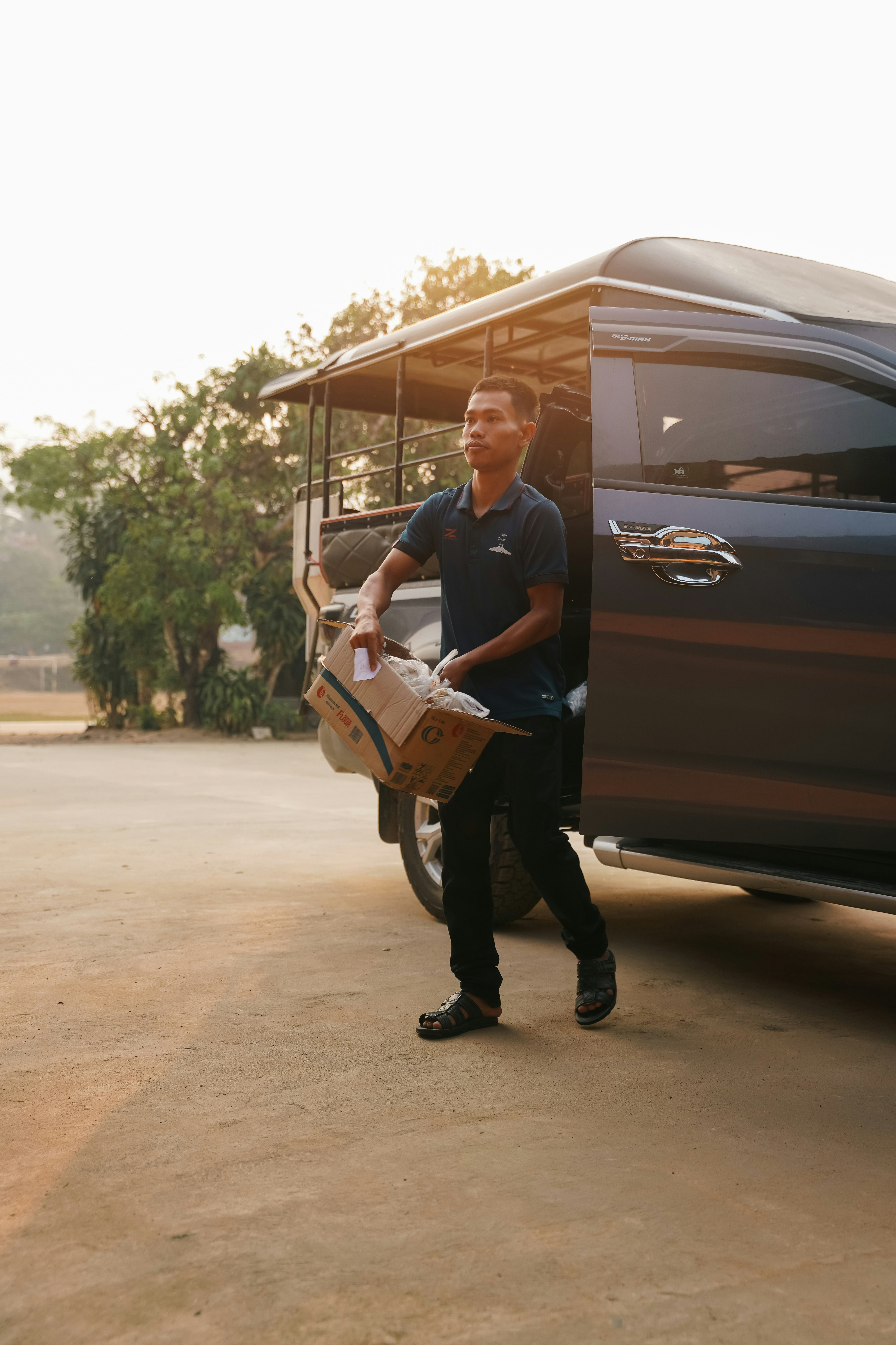 Box Carrier: A Man Hauls Hope from the Back of a Van