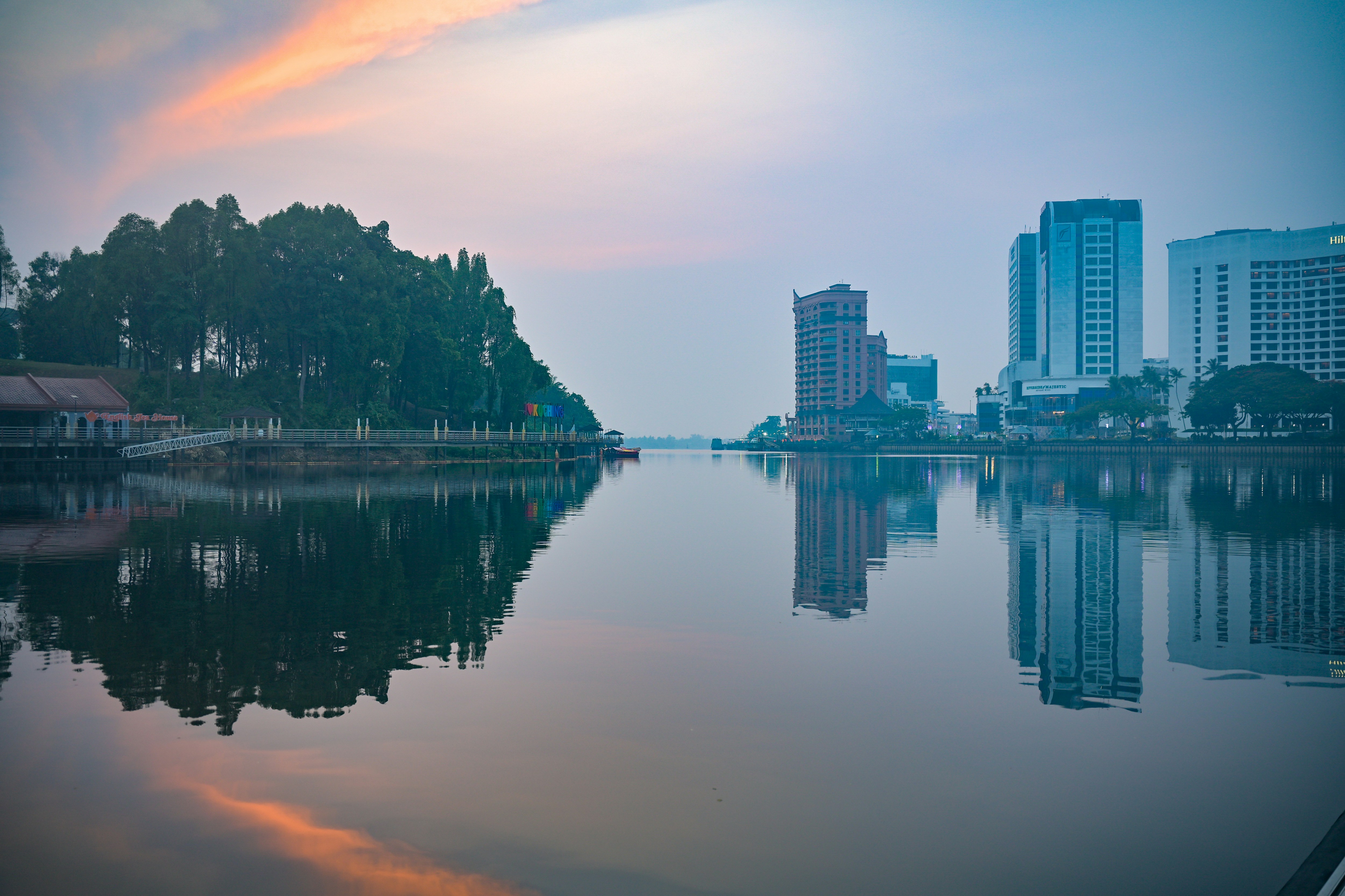Twin Reflections at Dusk Over a Modern Riverside