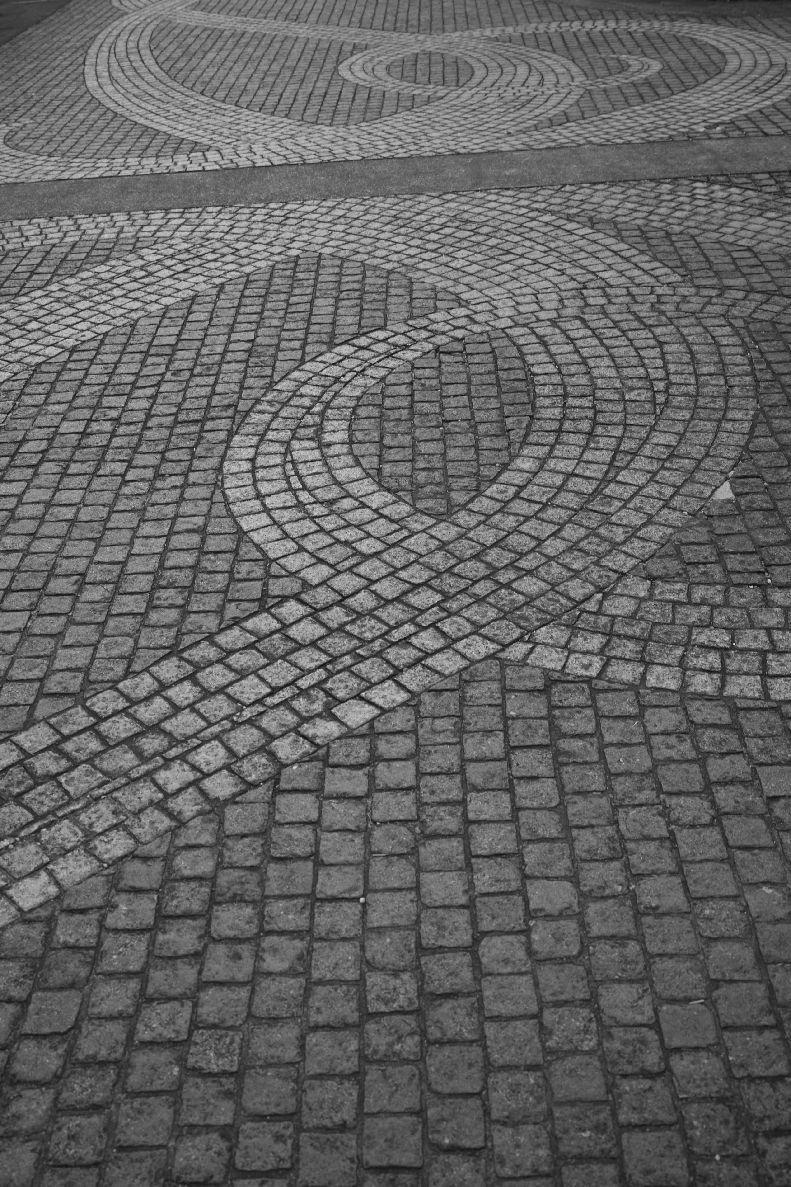 Patterns in Stone: A Graze Across Curved Cobble Waves