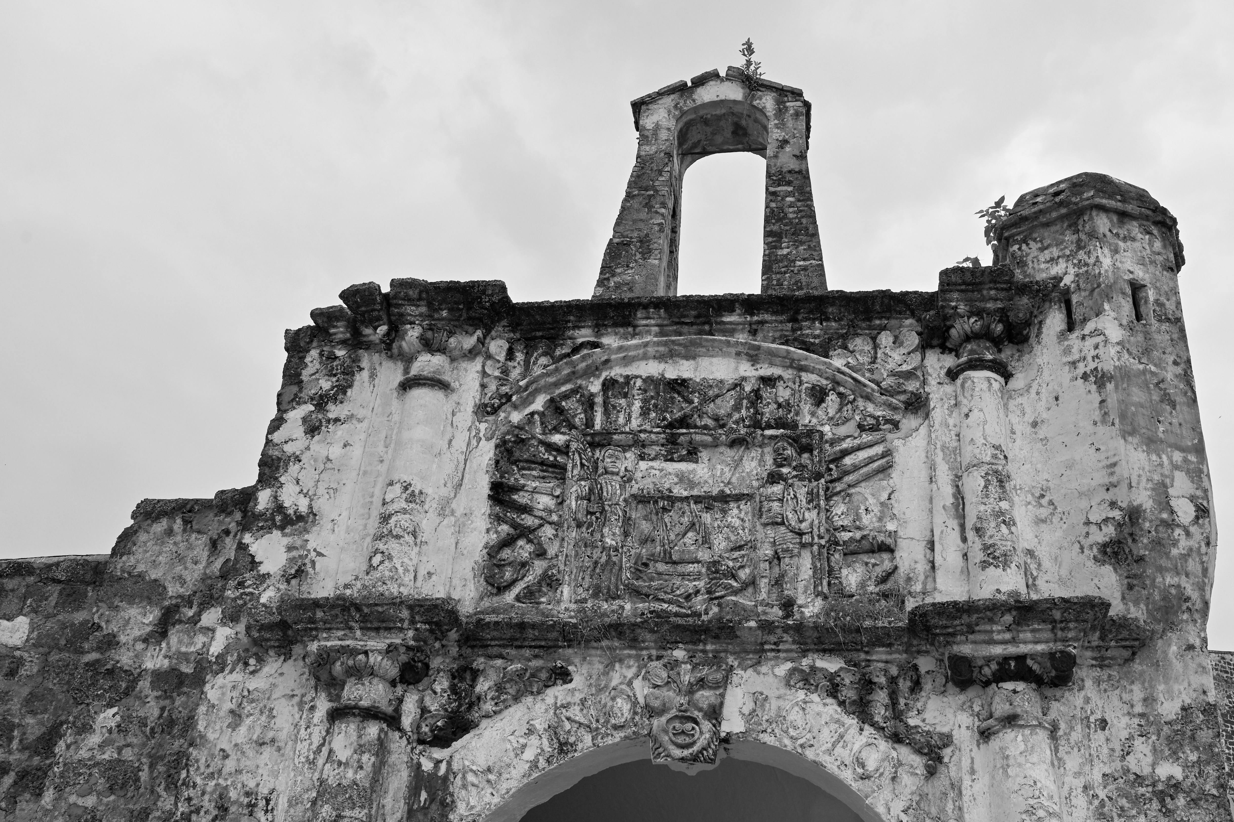 Ruins Framing: The Weathered Archtower in Monochrome