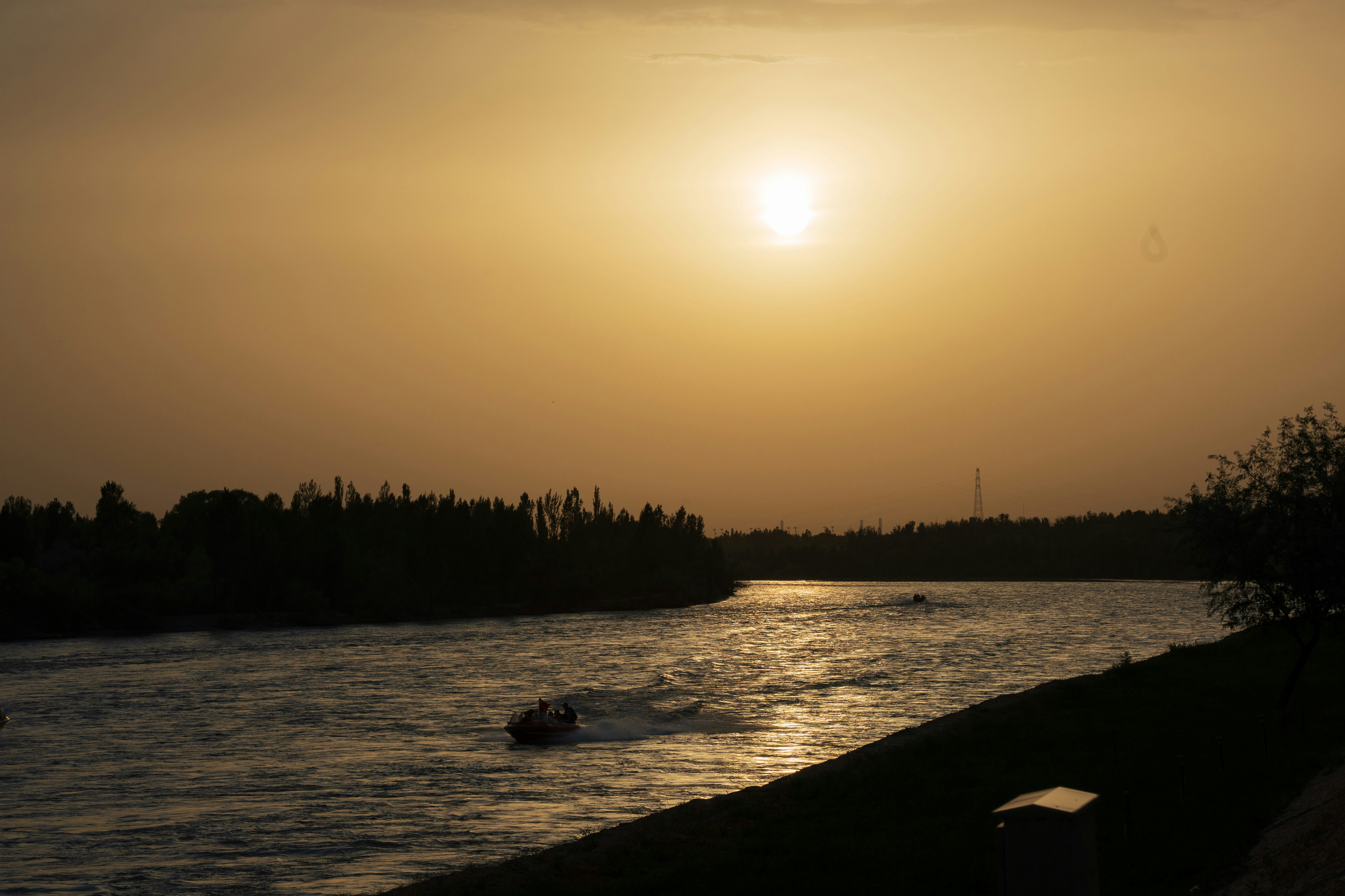 Dusk on the River: Silhouette and Sunset Glow