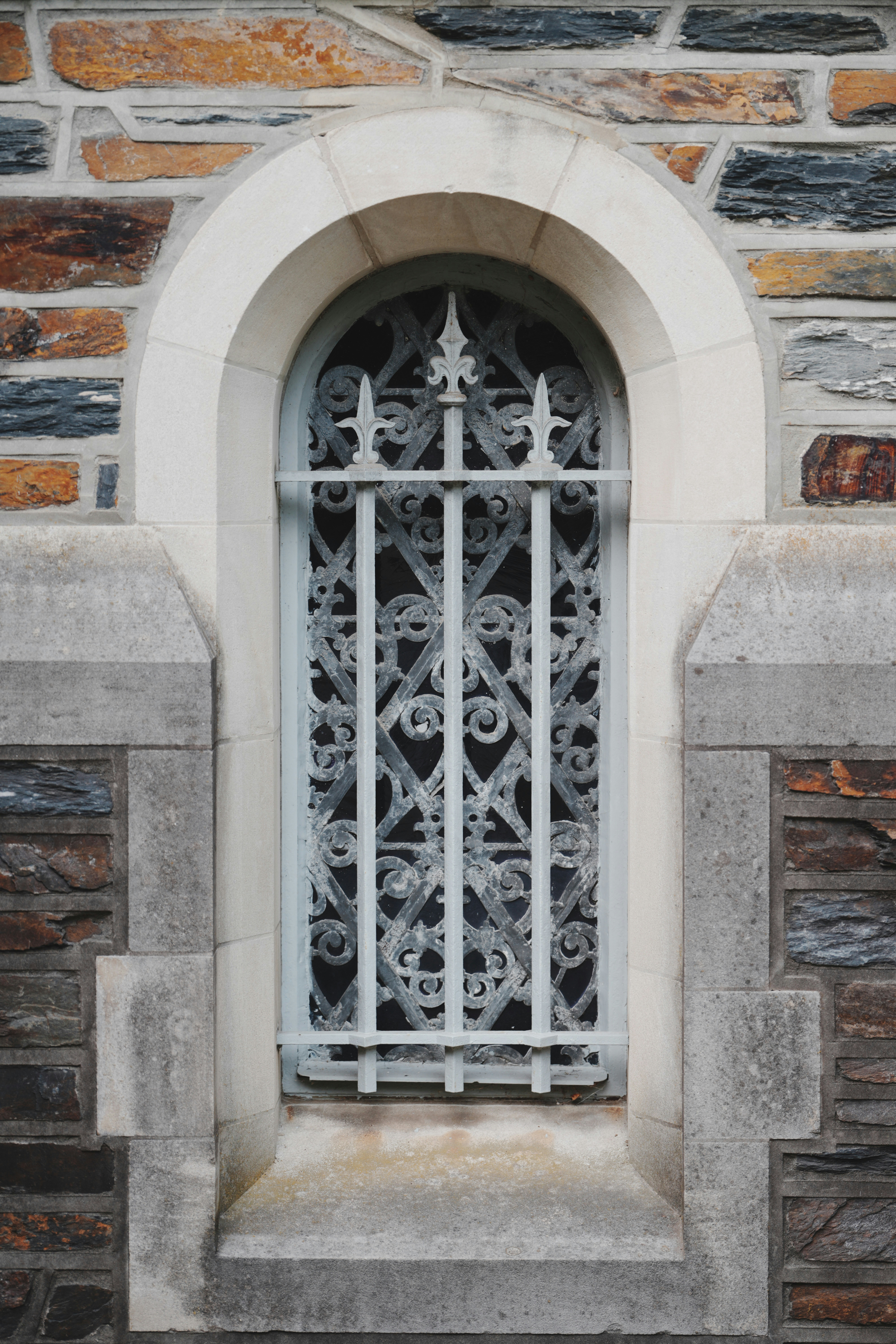 Archway of Ironwork: A medieval doorway framed in stone