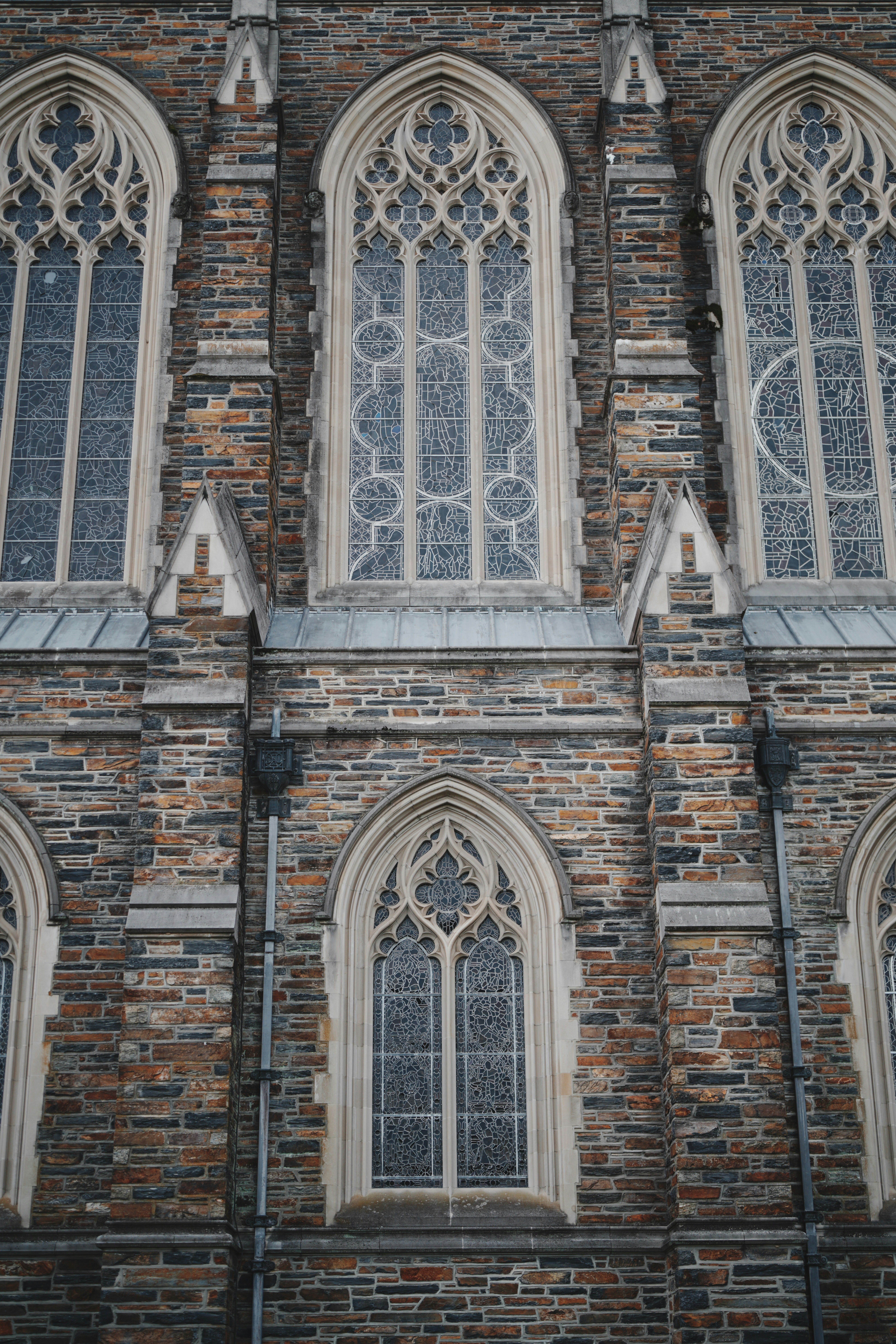 Gothic Glass and Stone: Vertical Cathedral Windows in Weathered Brick