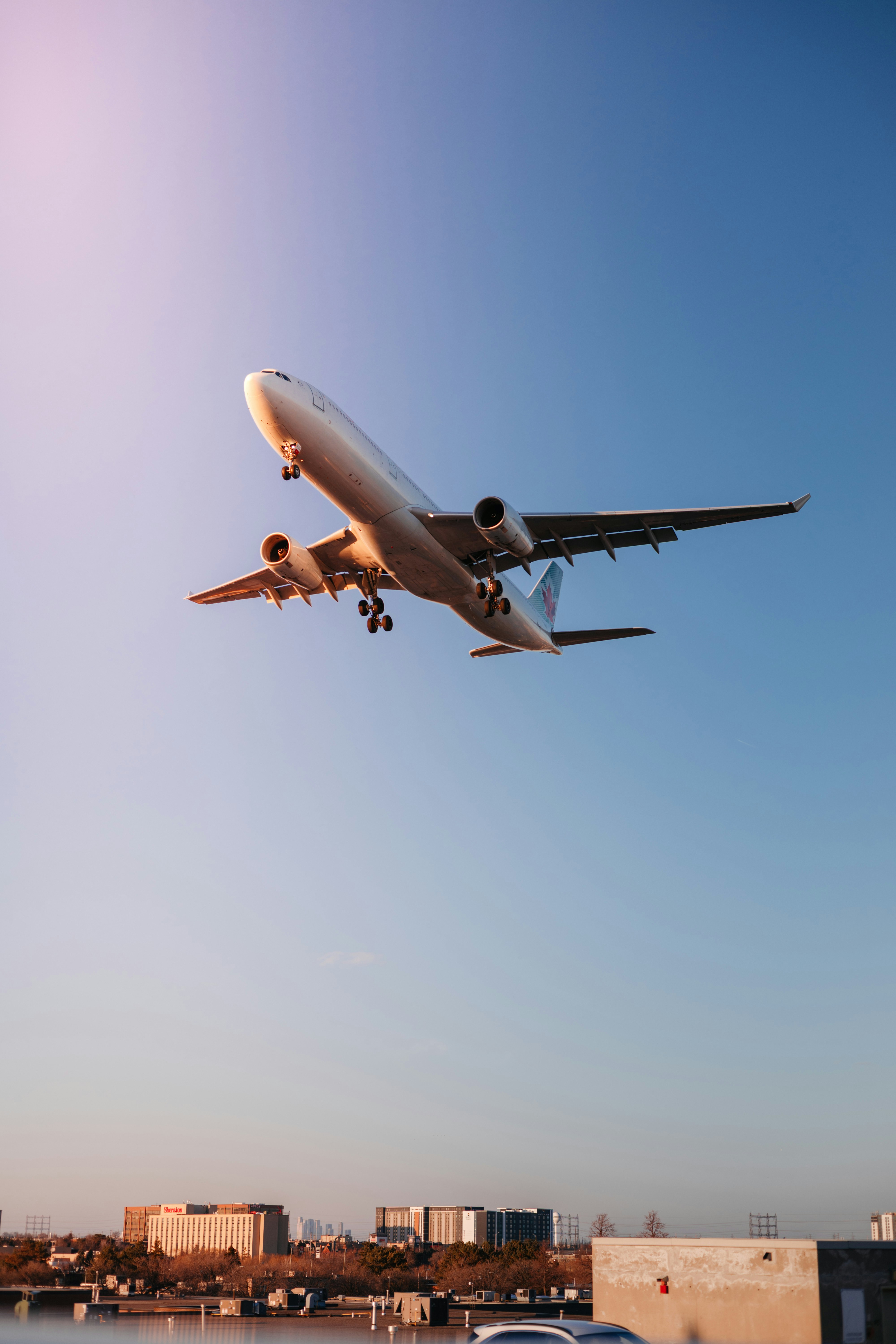 Jetliner Descends Over the City at Dusk