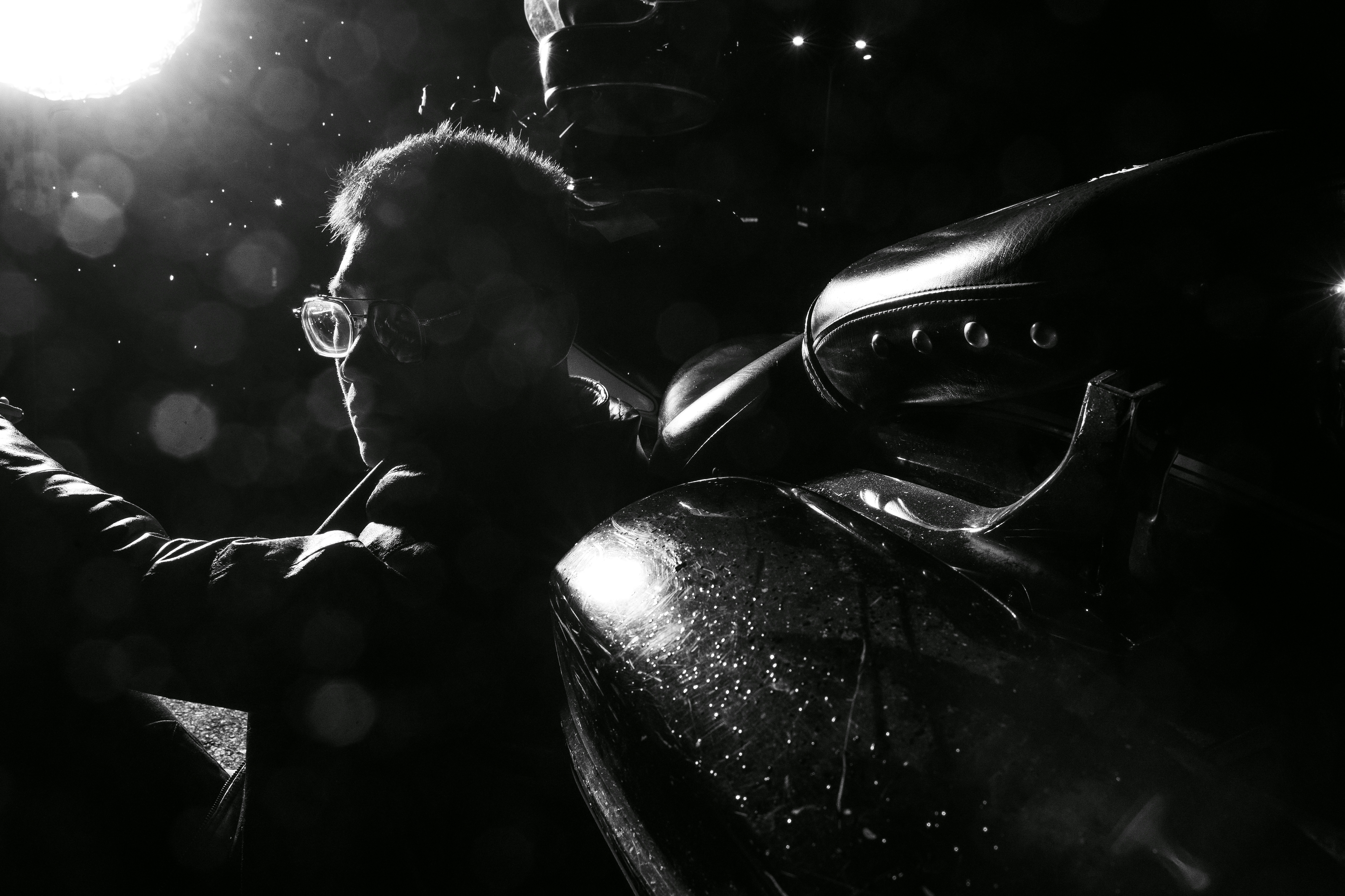 Glow on Leather: A Shadowed Ride Amid Static Sparks