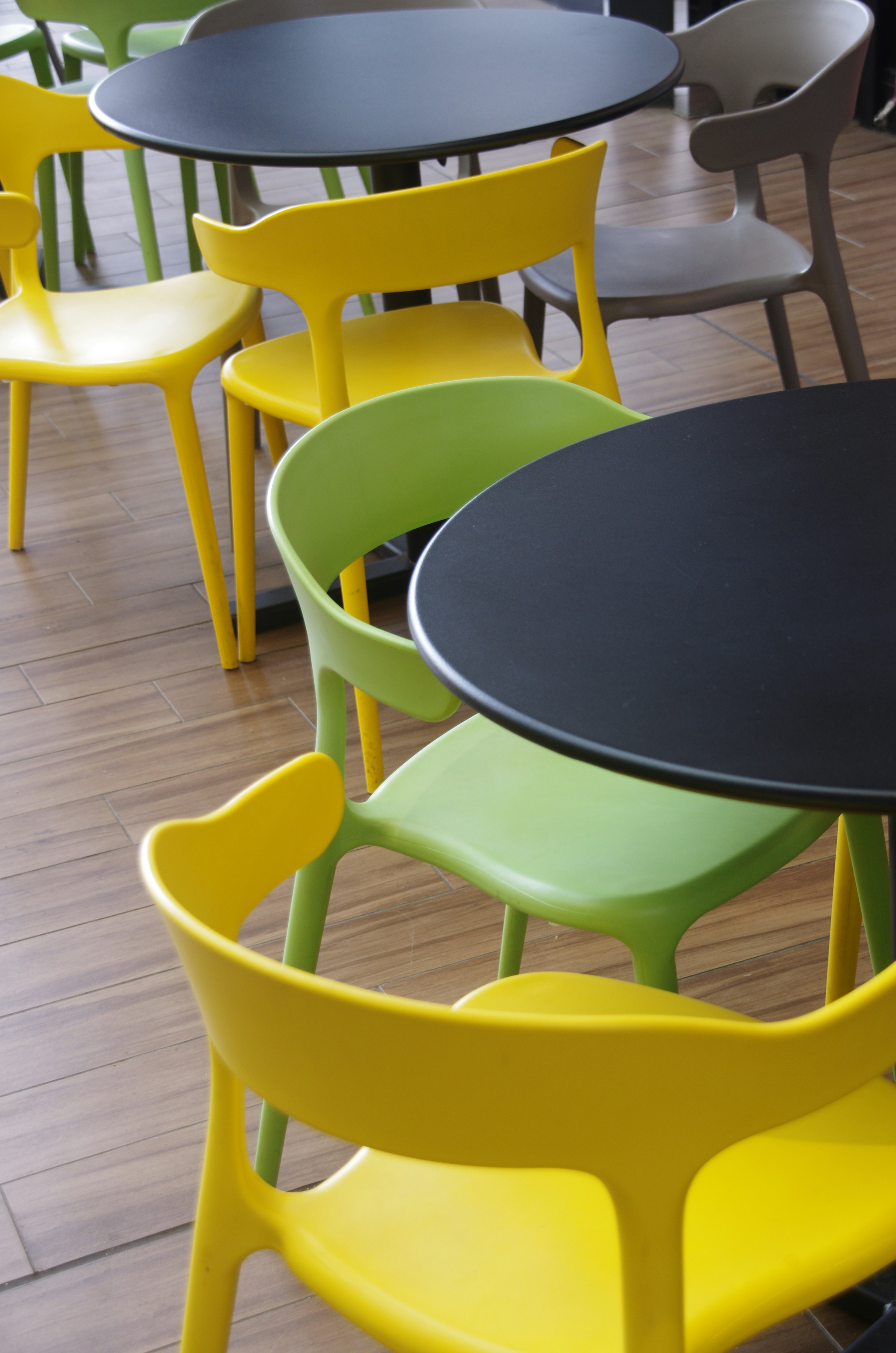 Colorful Seating Parade: A Café's Playful Arrangement of Chairs and Tables