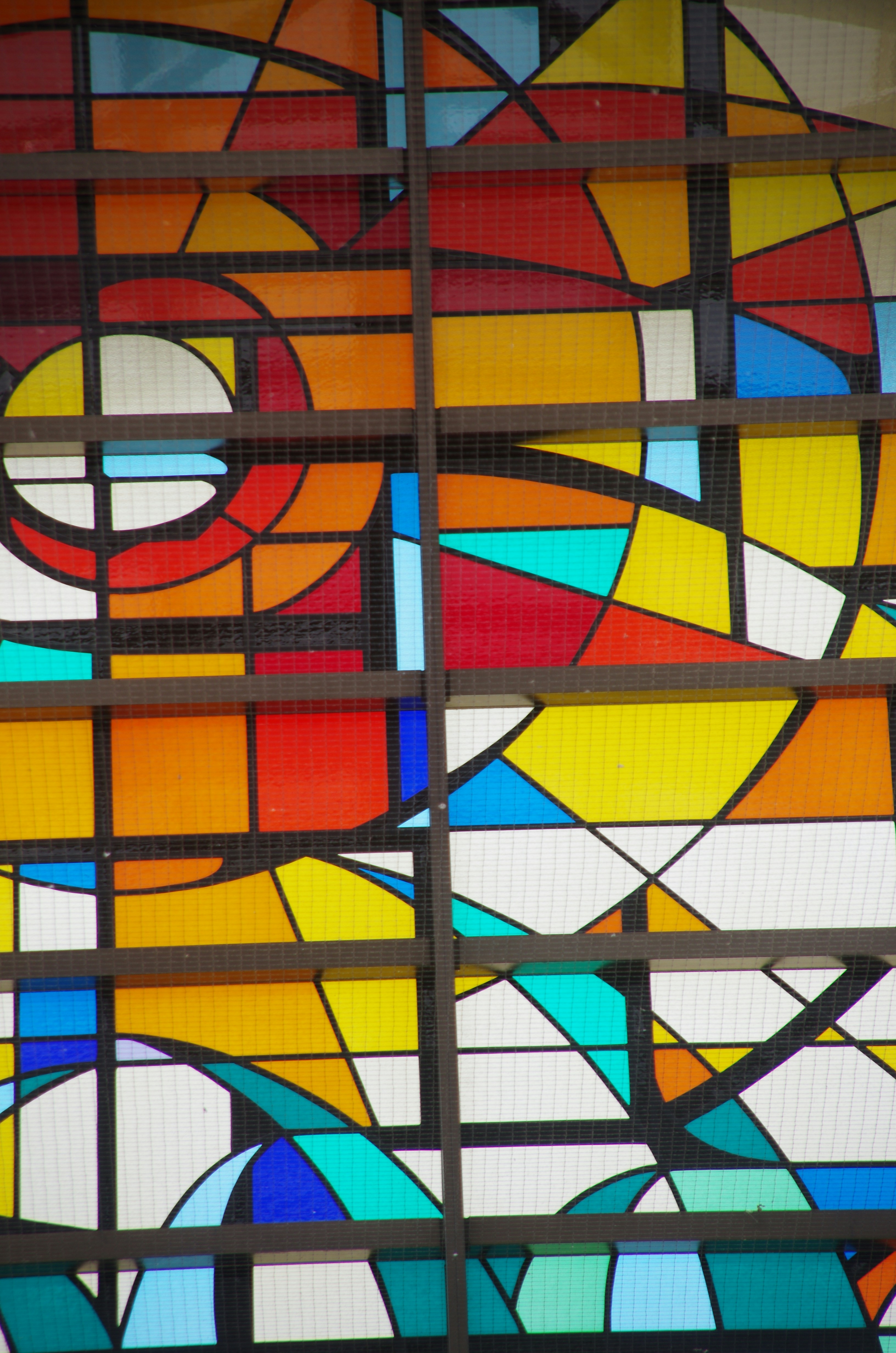 Chromatic Mosaic: Stained Glass Grid Beneath a Woven Curtain