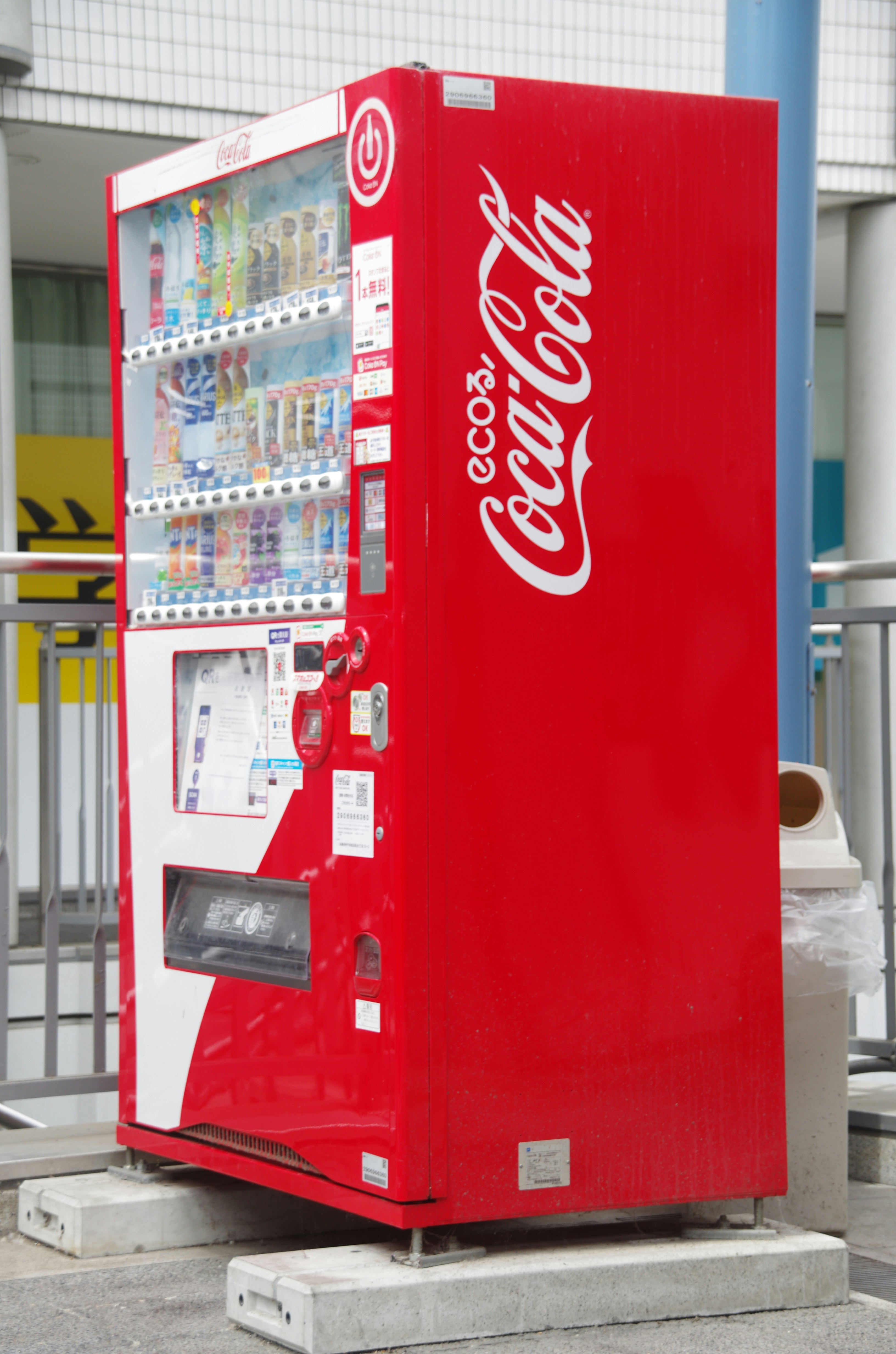 Crimson Vending: A Coca‑Cola Standout in Urban Grey