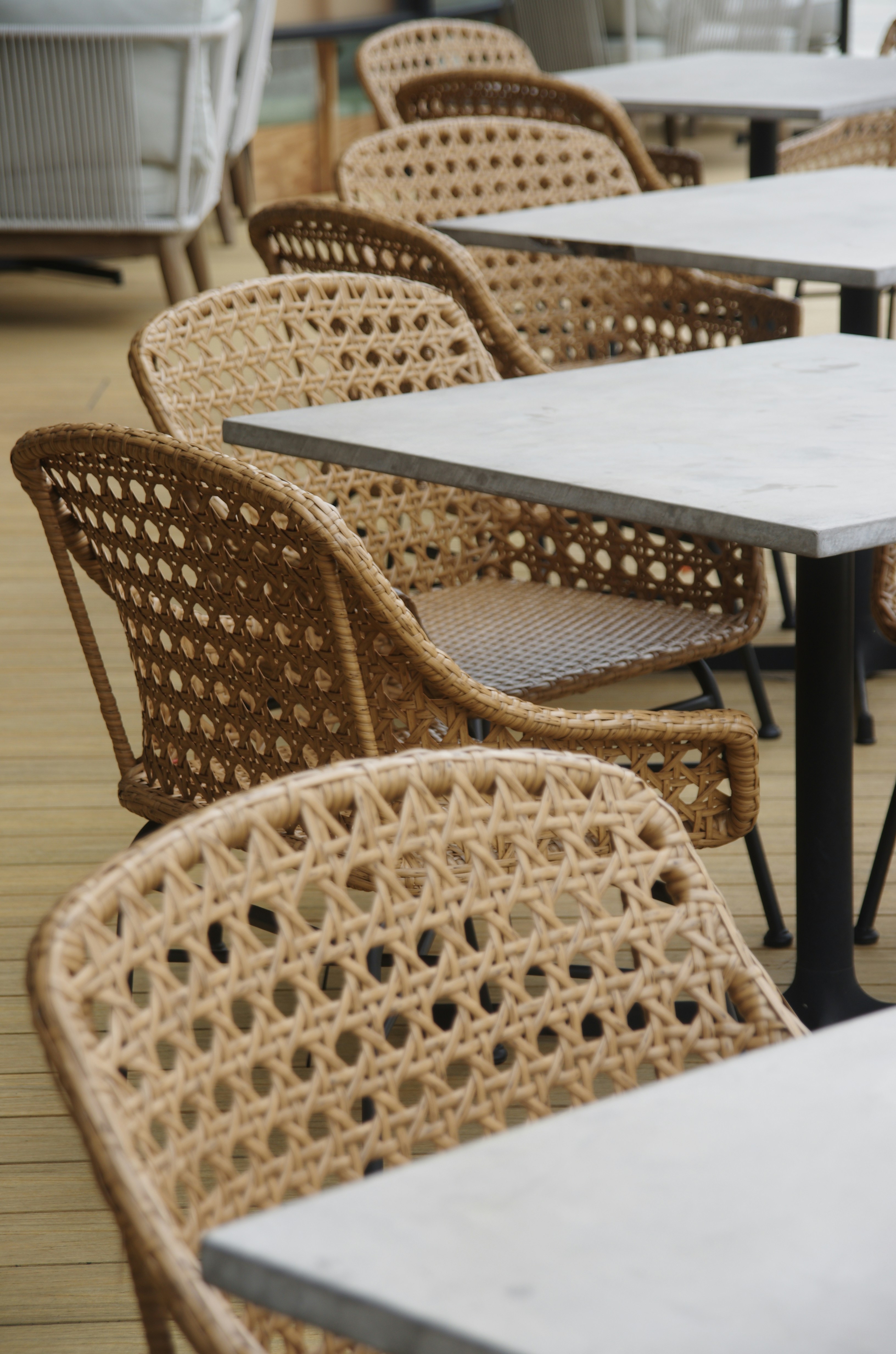 Rows of Woven Chairs Embrace Light at a Quiet Patio