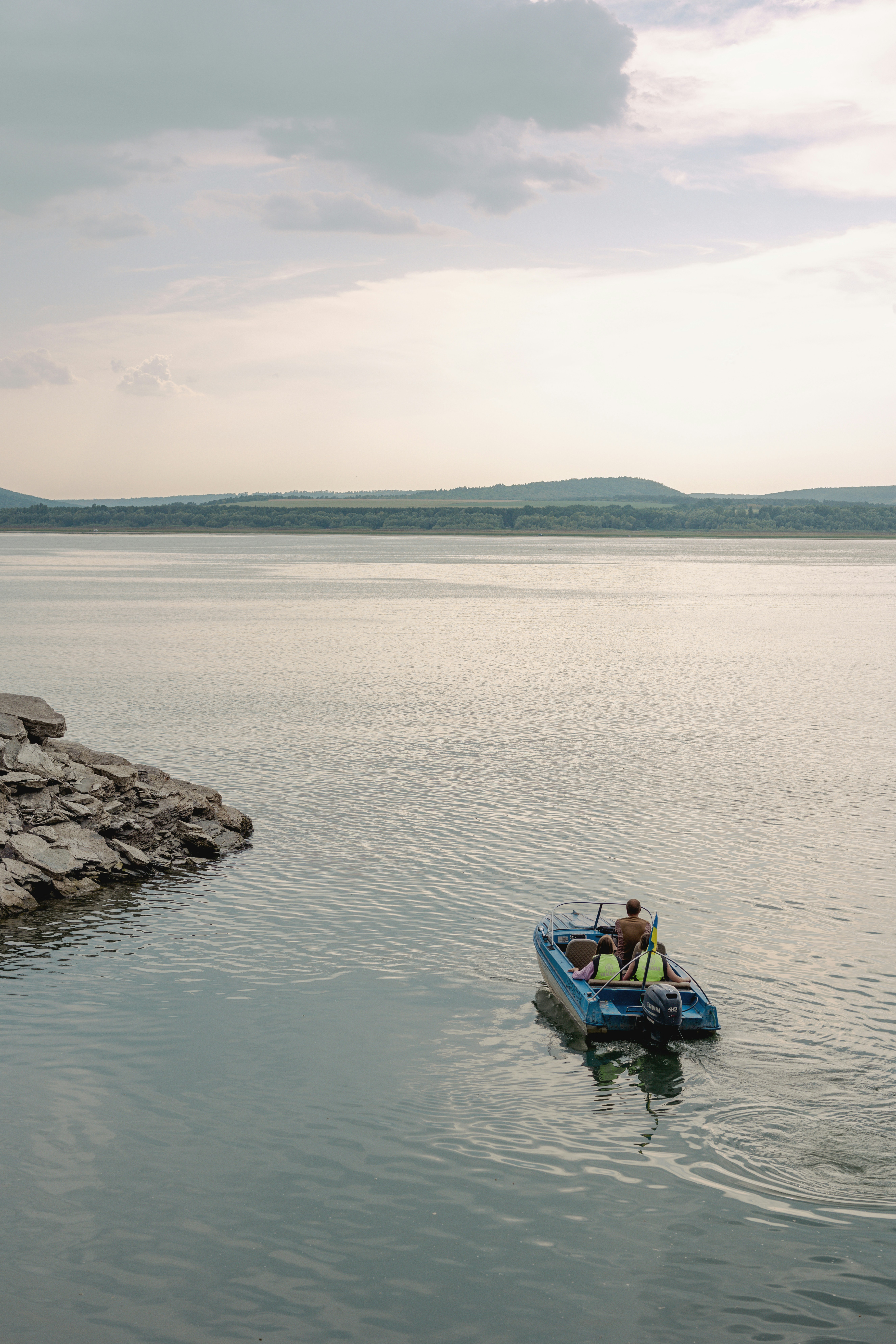 Blue Boat at Quiet Dusk: A Serene River Crossing