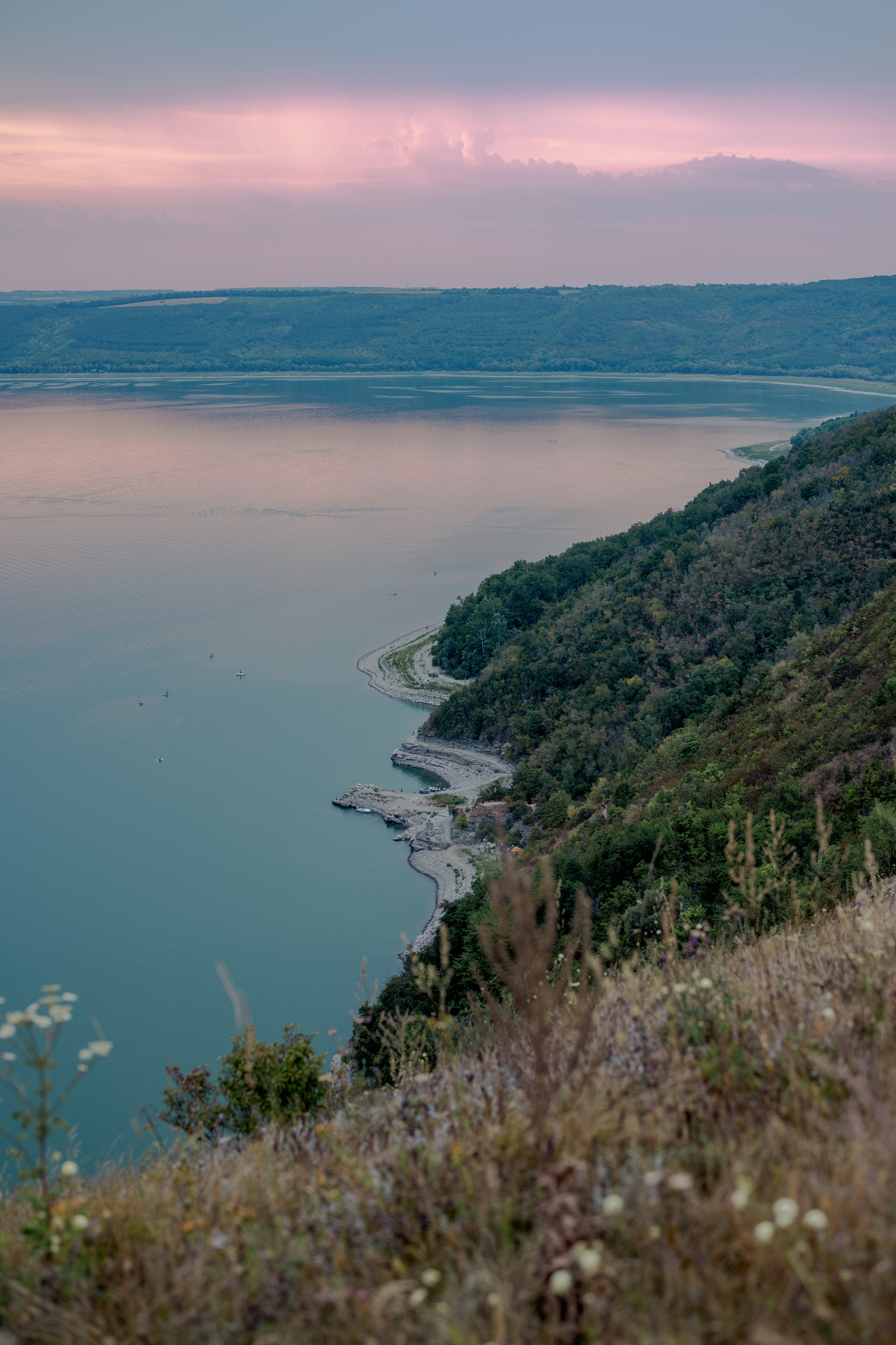 Sunset Over the Curved Shore: A Quiet Lake View from the Slope