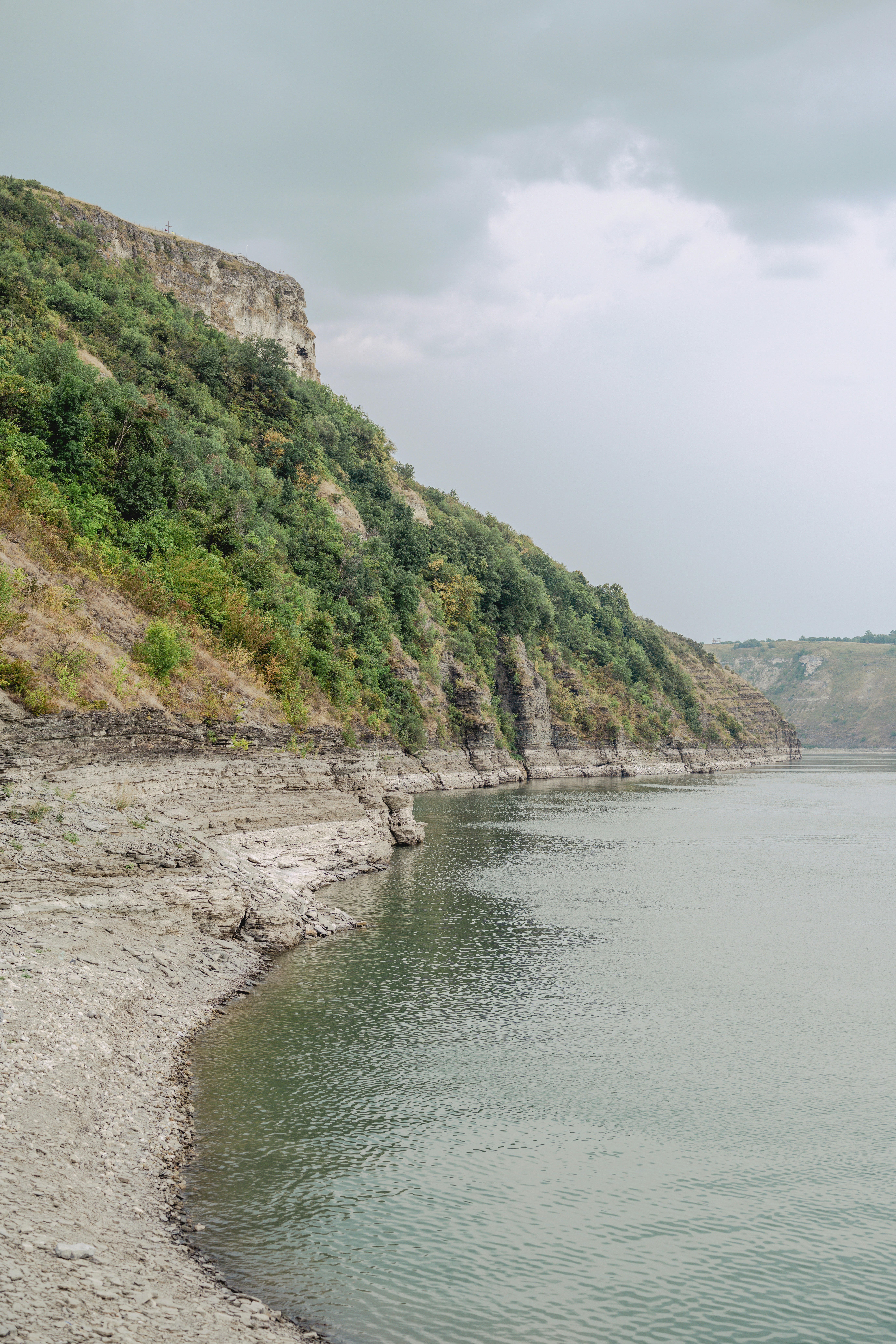 Layered cliffs and calm inlet: a quiet riverside panorama