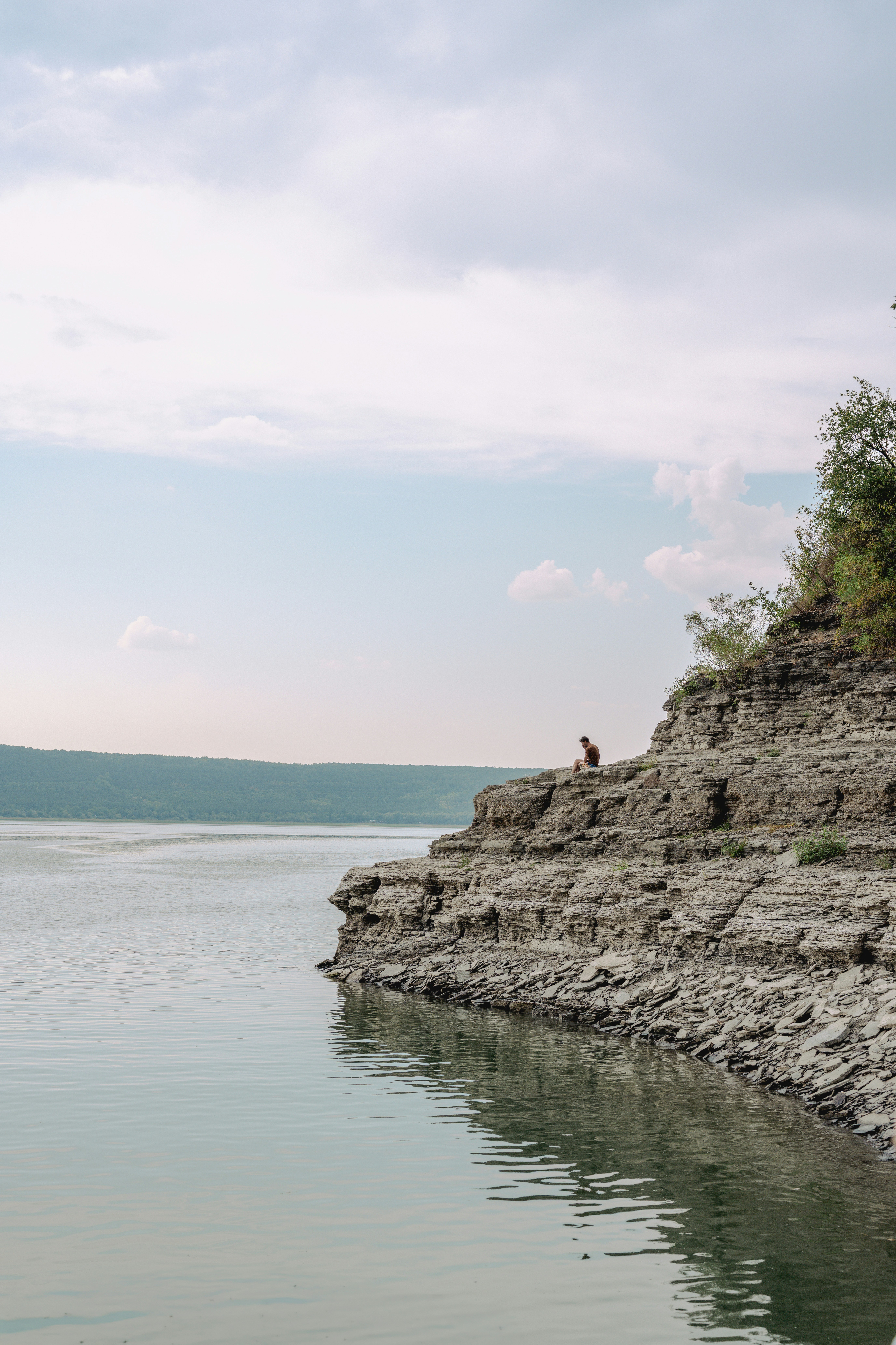 Cliffside Contemplation by the Quiet Lake