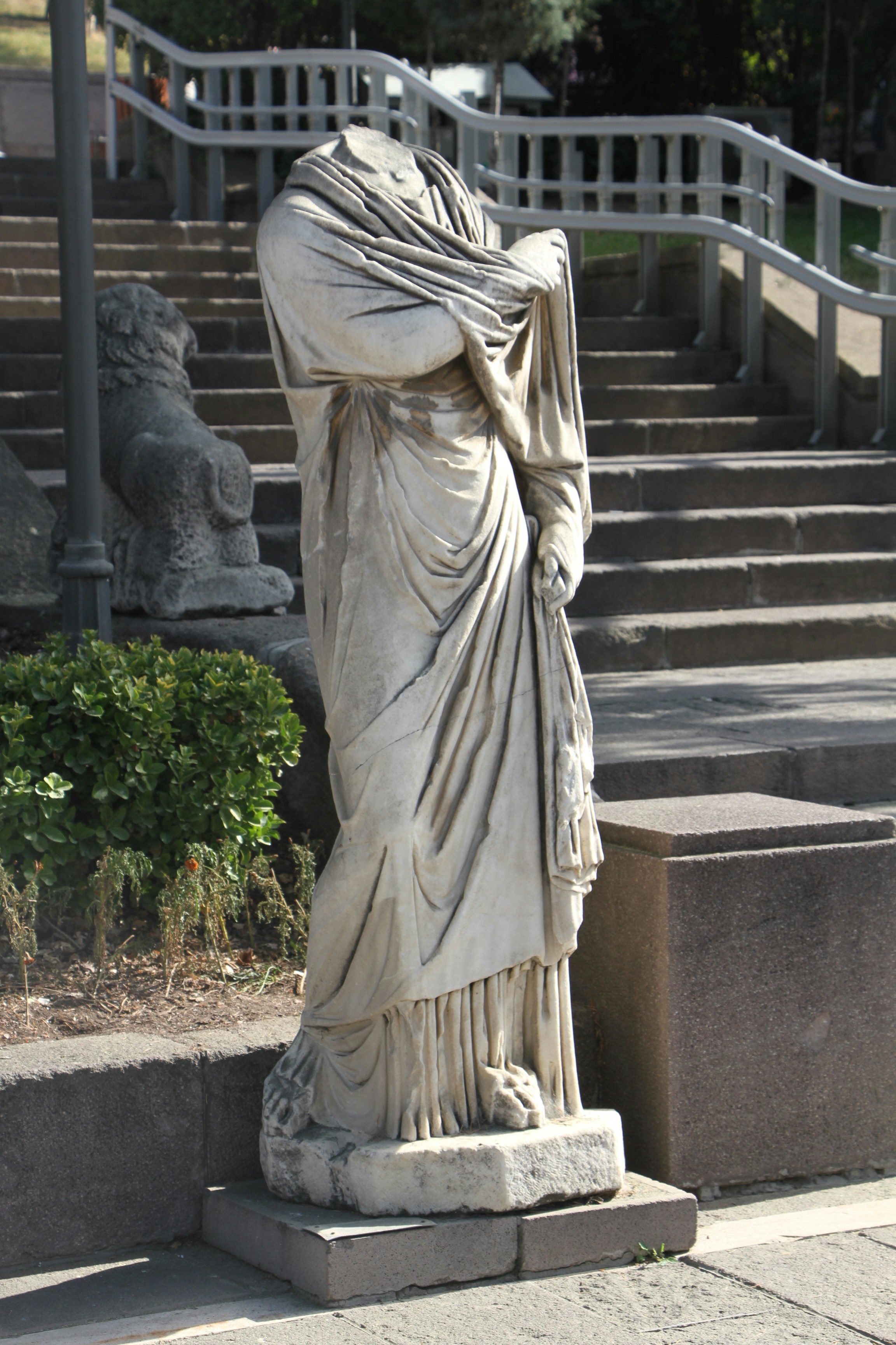 Headless Statue in a Tidy Staircase Garden