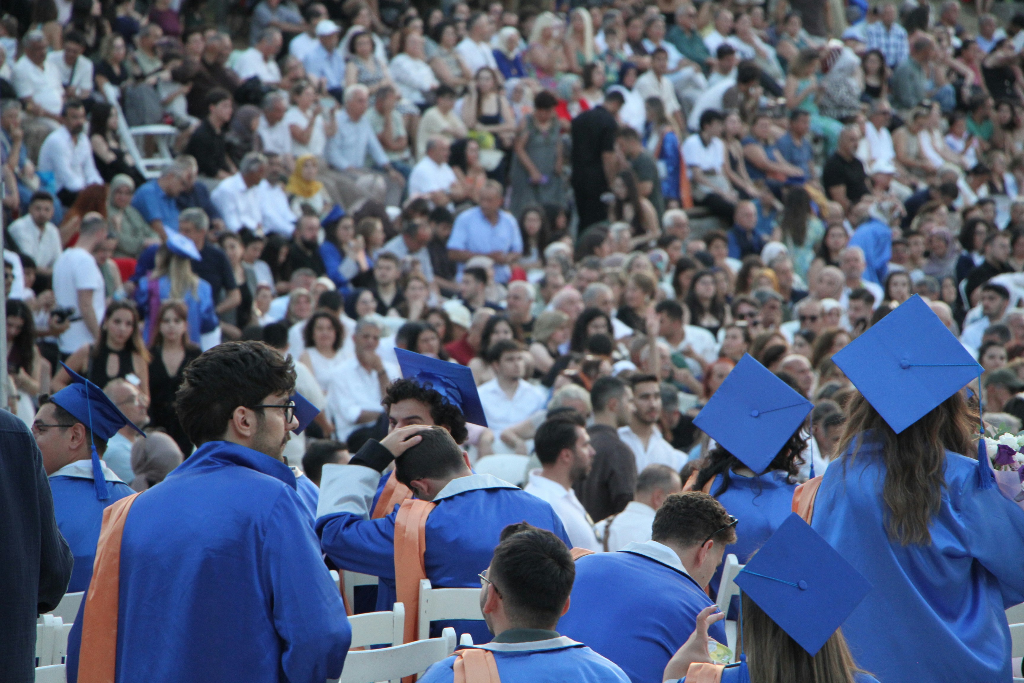Blue Gowns, Bright Futures: Graduation Day Amid a Sea of Spectators