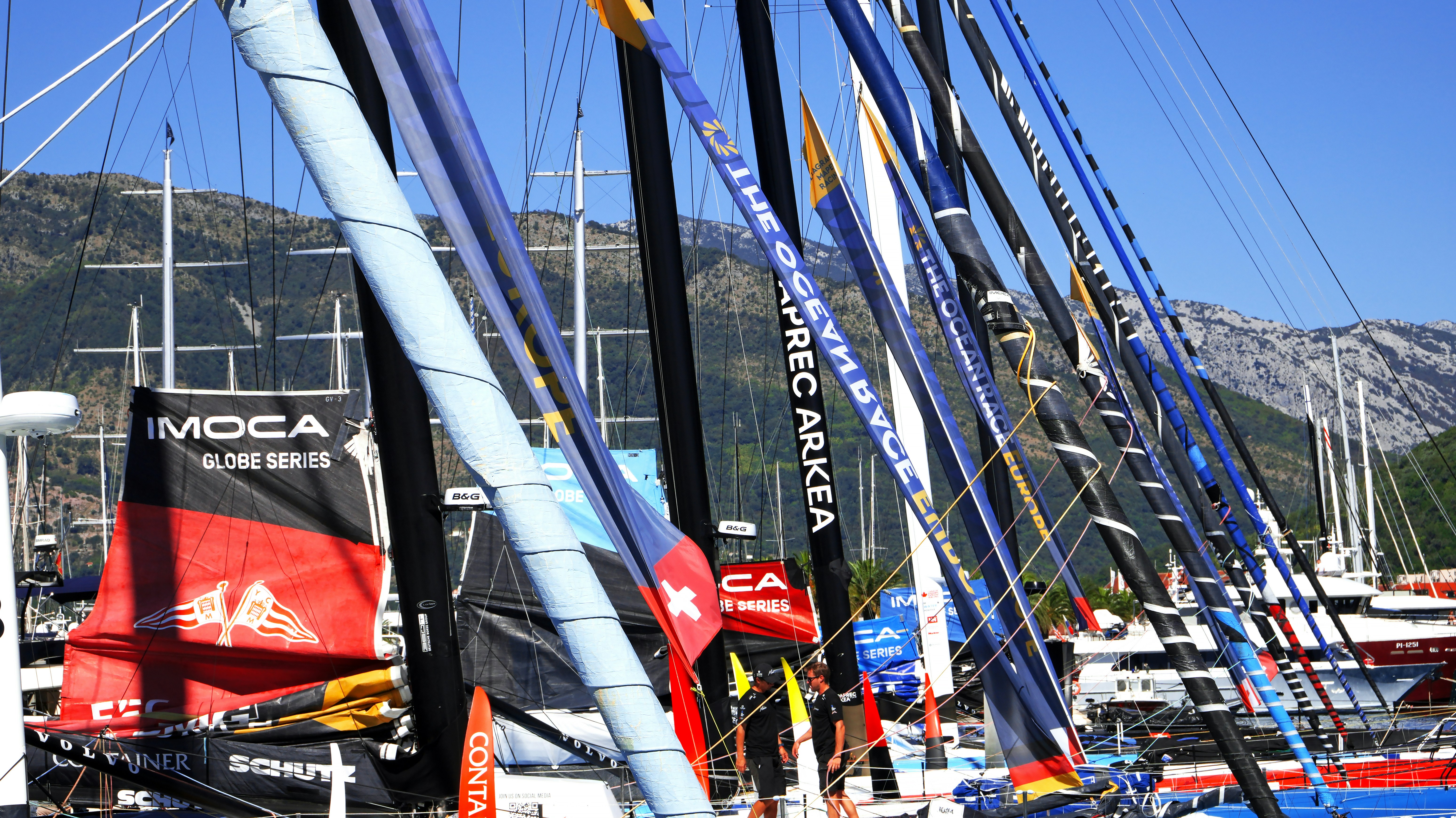 Vibrant Sailboat Marina: Flags and Masts Rippling in a Mountain Harbor
