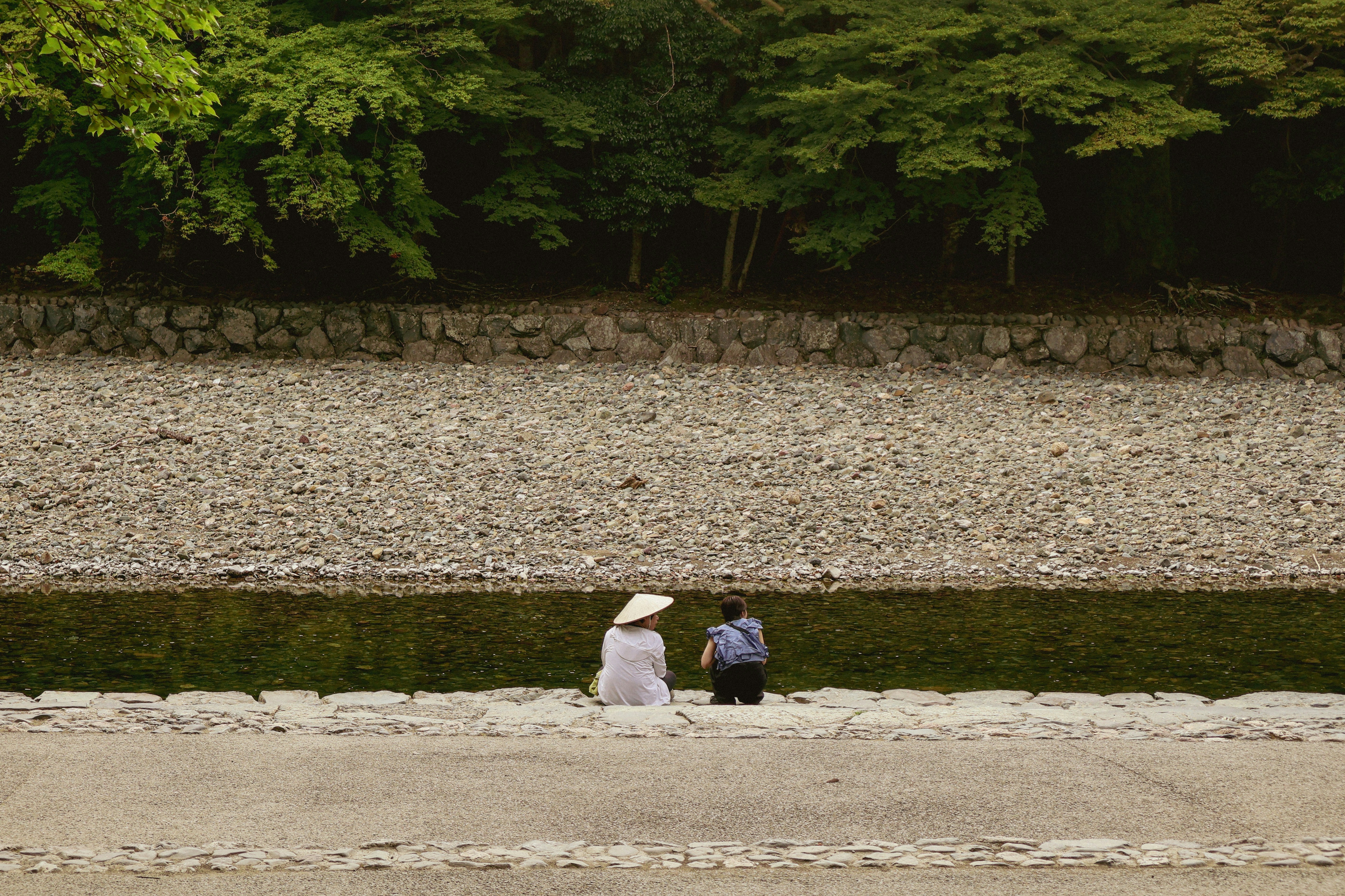 Two Quiet Figures by the Riverside: A Moment of Shared Silence