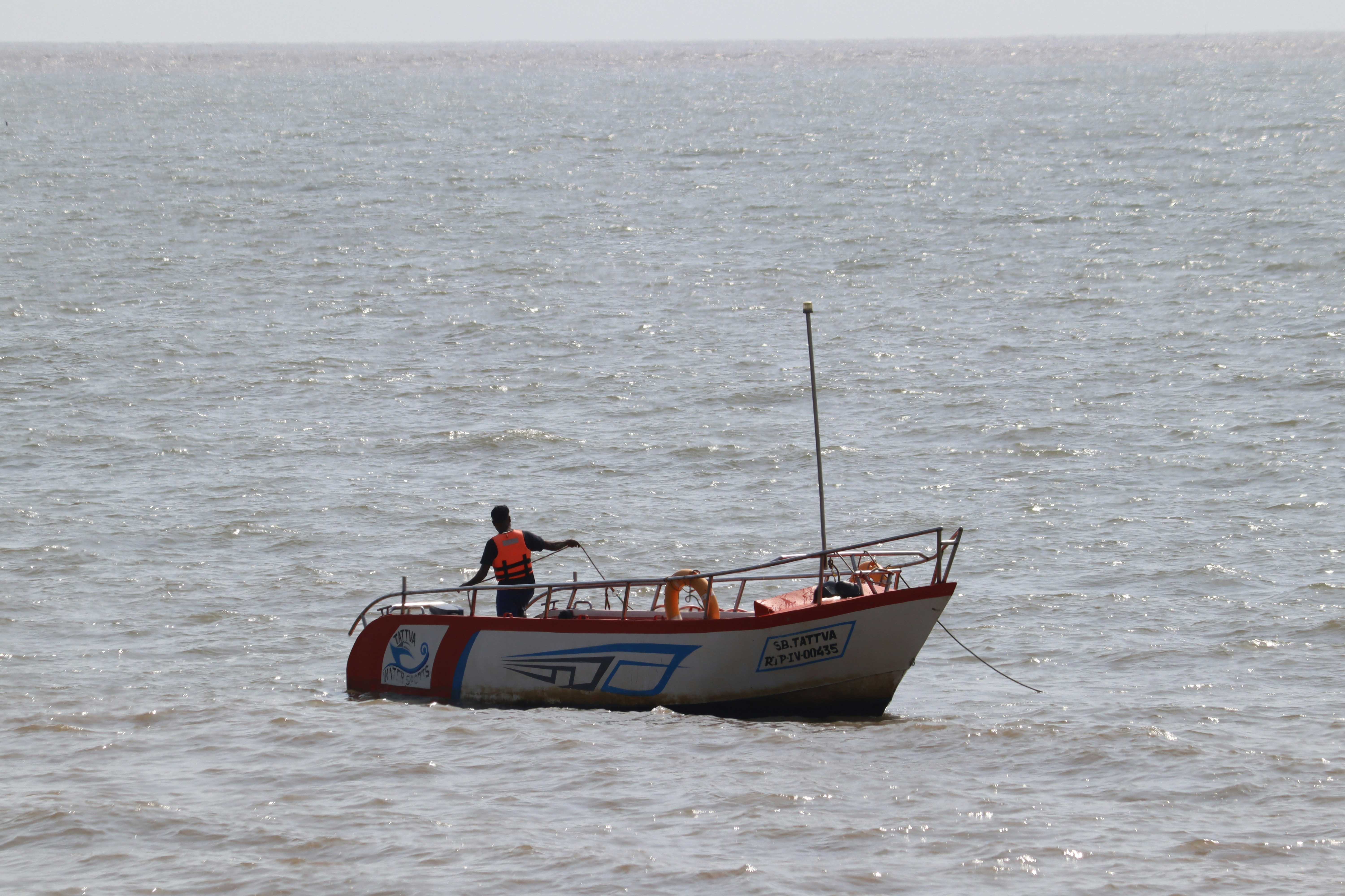 Coasting Lifeline: The Red-Deck Boat Amid Quiet Seas