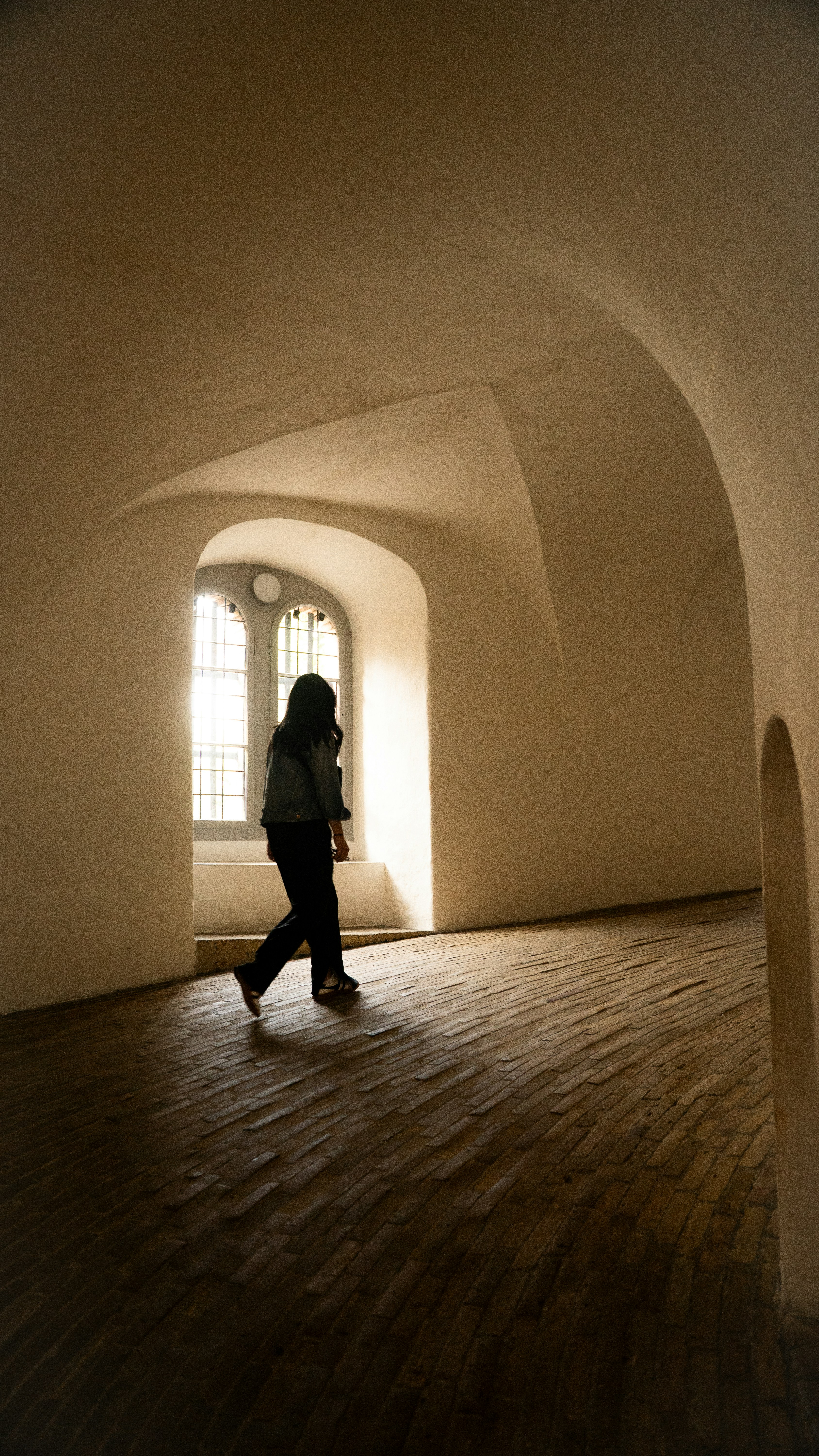 Footsteps in the Archicery: A lone figure in the warm chapel