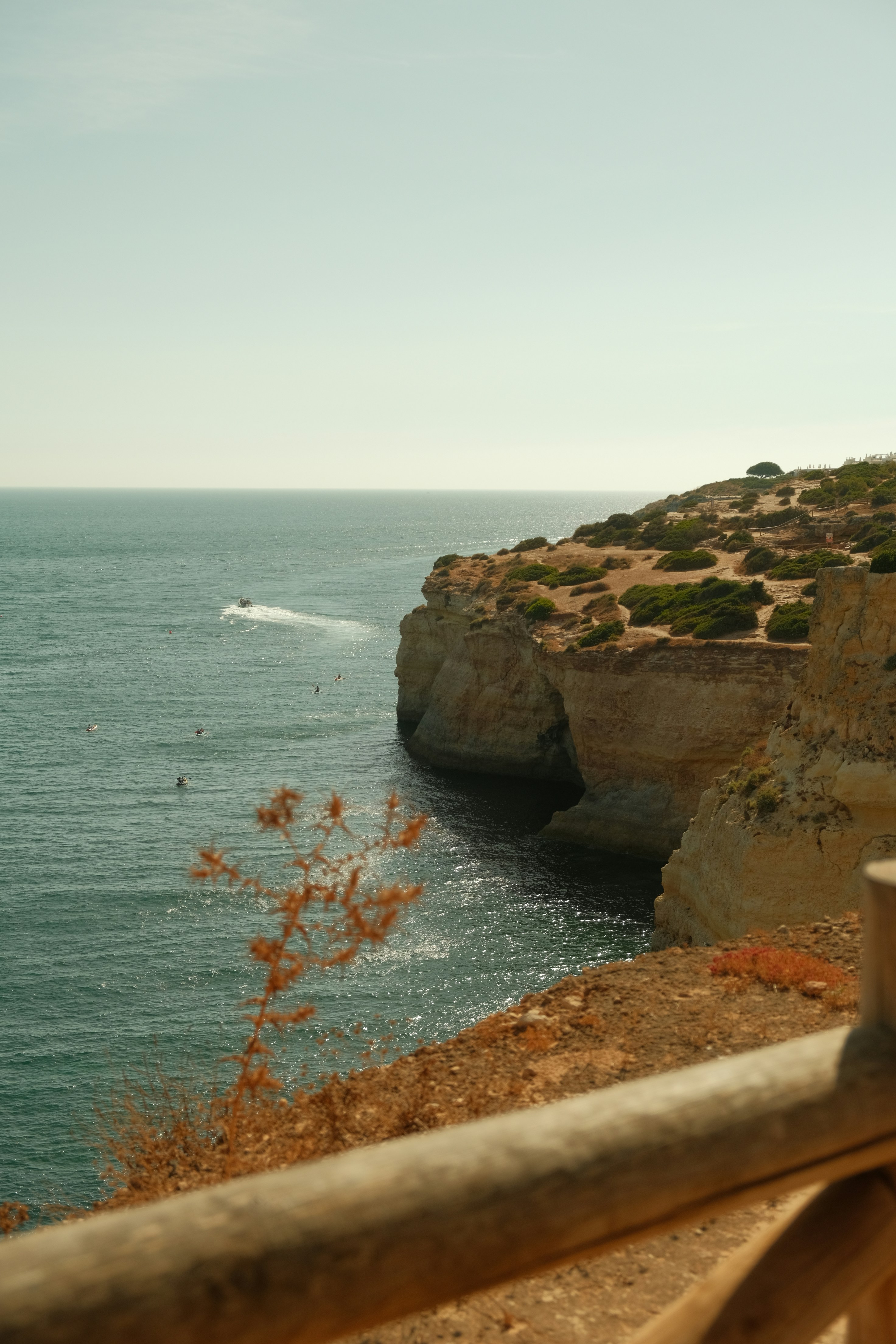 Cliffside Vista: Sunlit Sea and Weathered Terrain