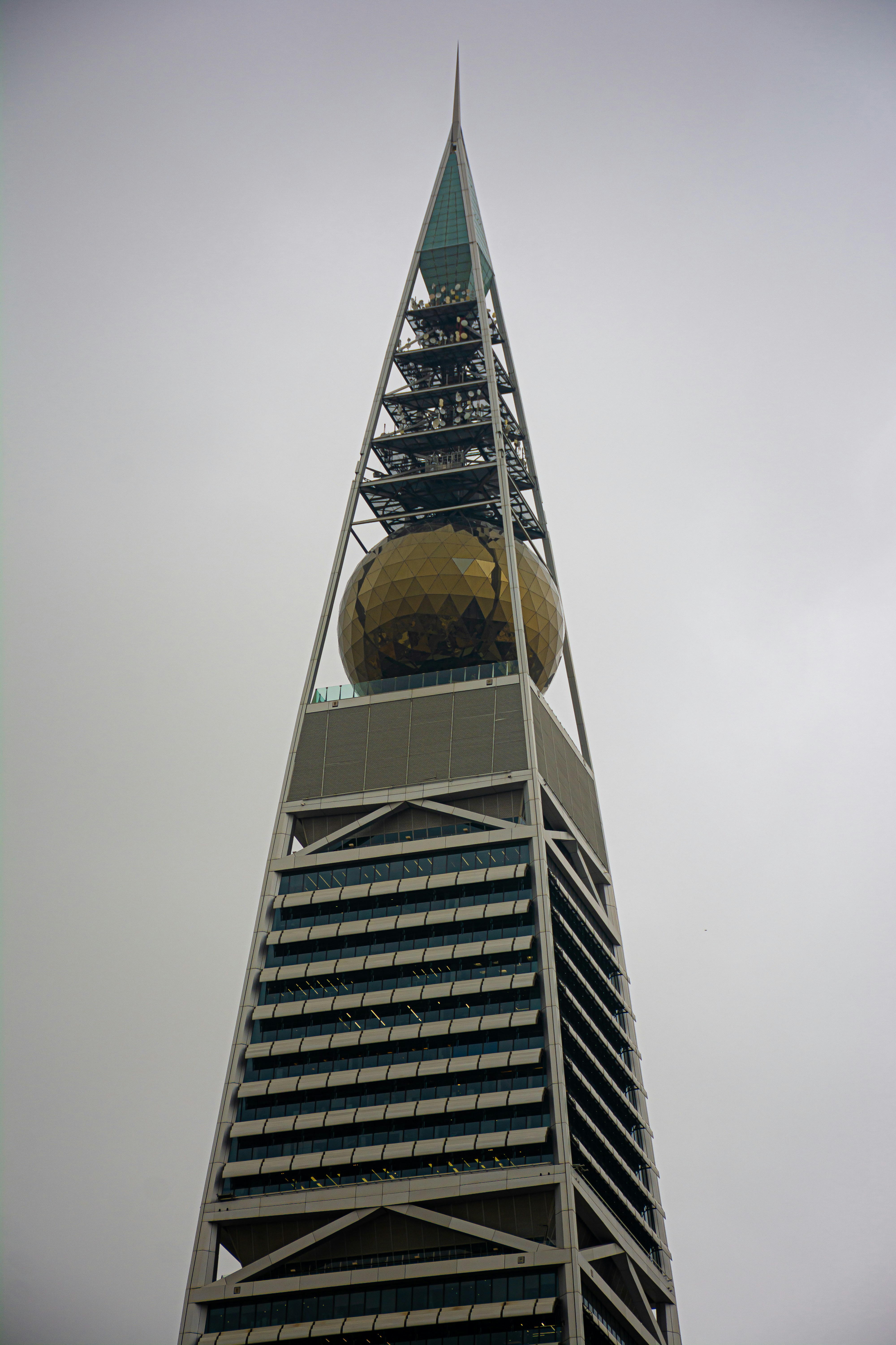 Spires and Sphere: A Skyscraper Crowned by Gold Geometry