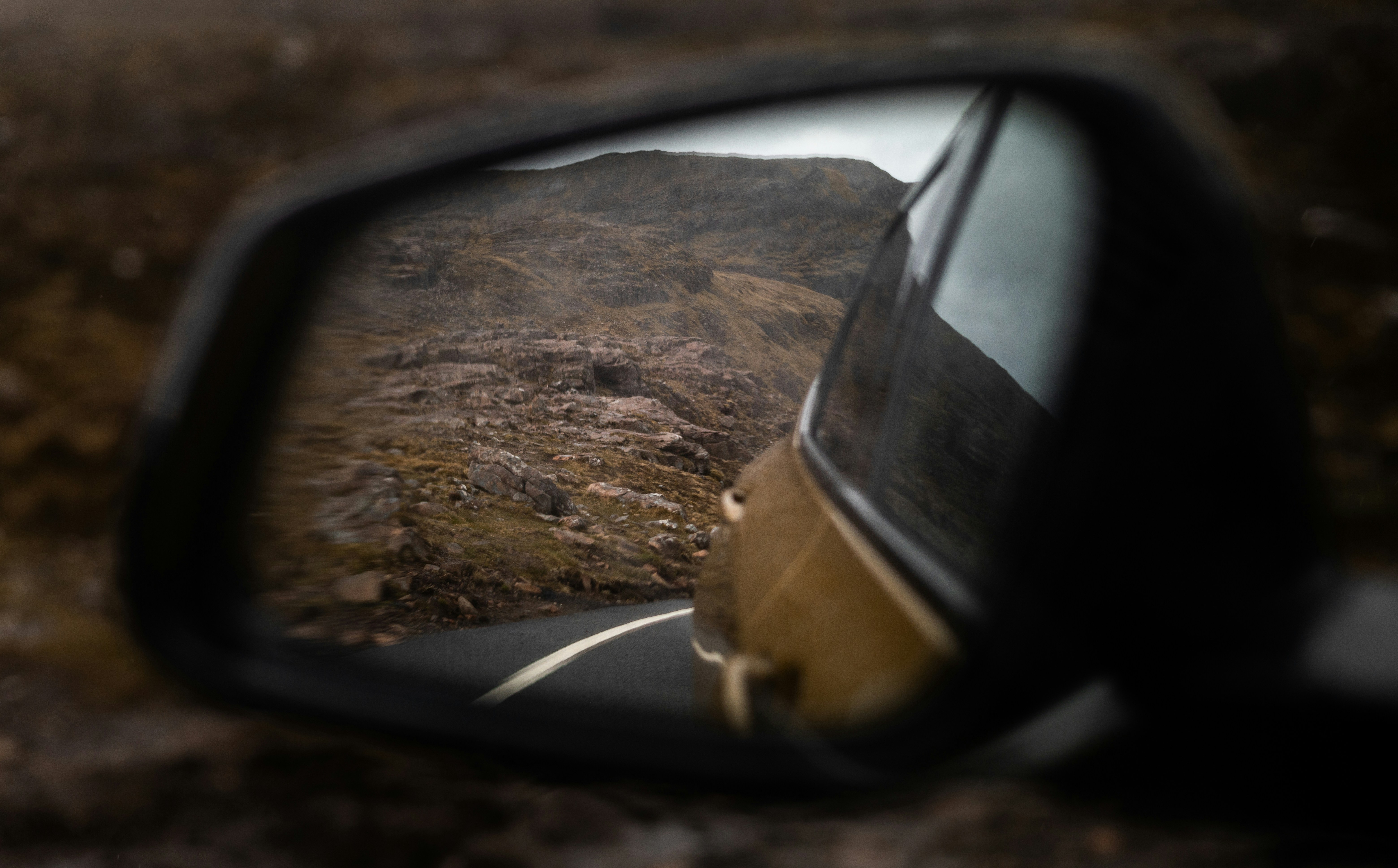 Mirror Road: Mountains Framed in a Side-View of a Vehicle