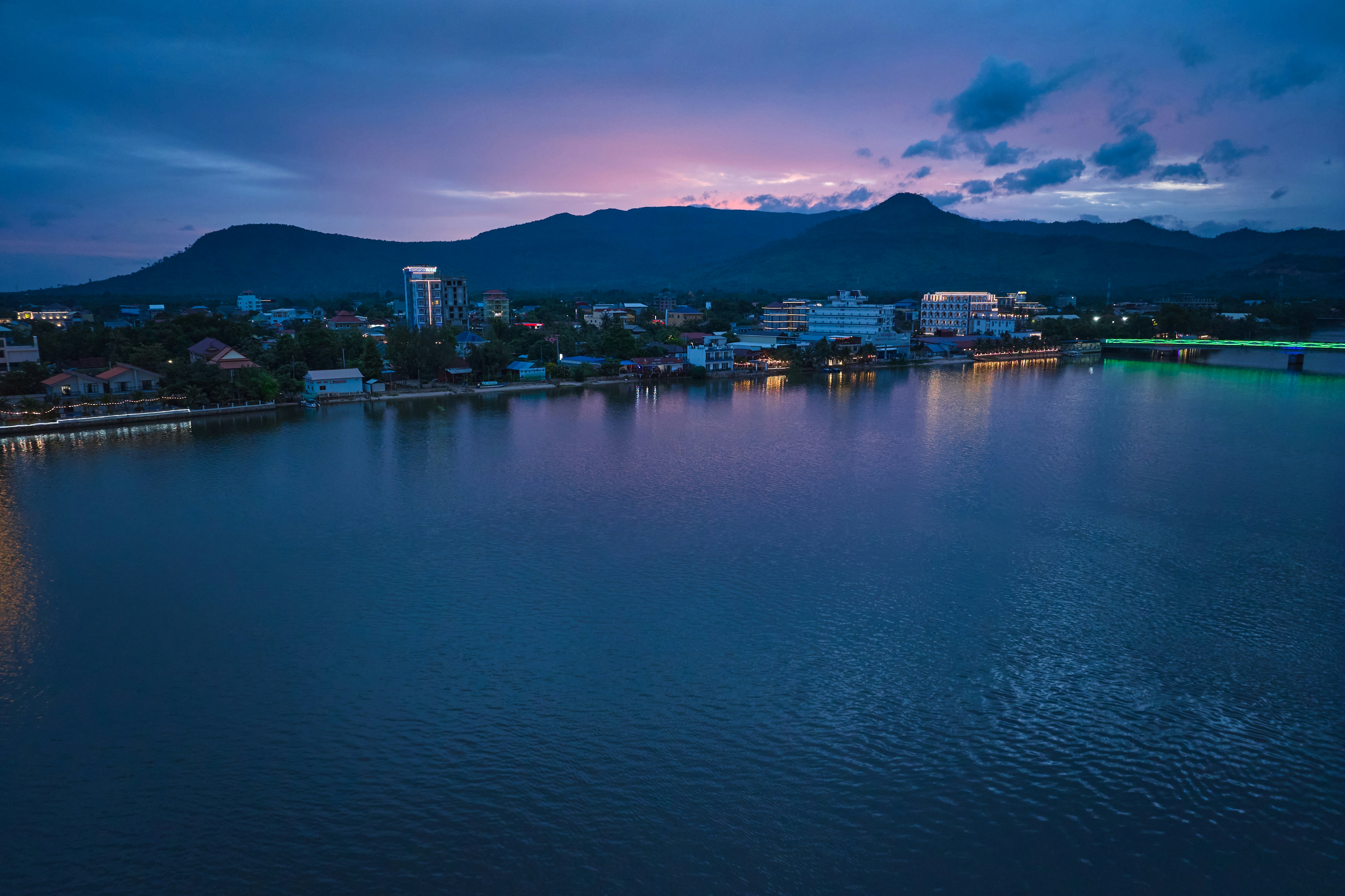 Dusk Over the River: A Quiet Town Embraced by Hills