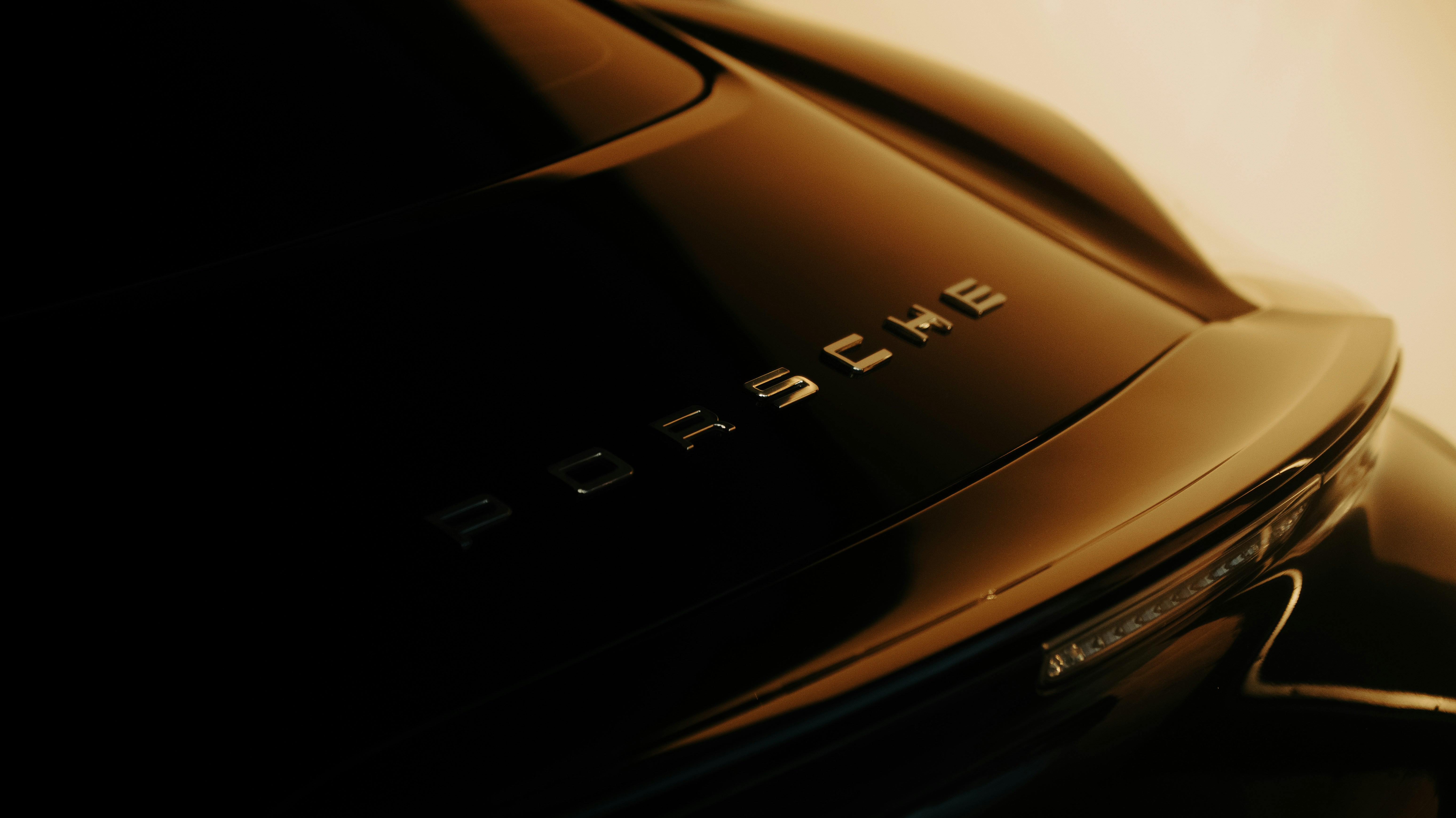 Shaped silhouette: Porsche badge in warm twilight