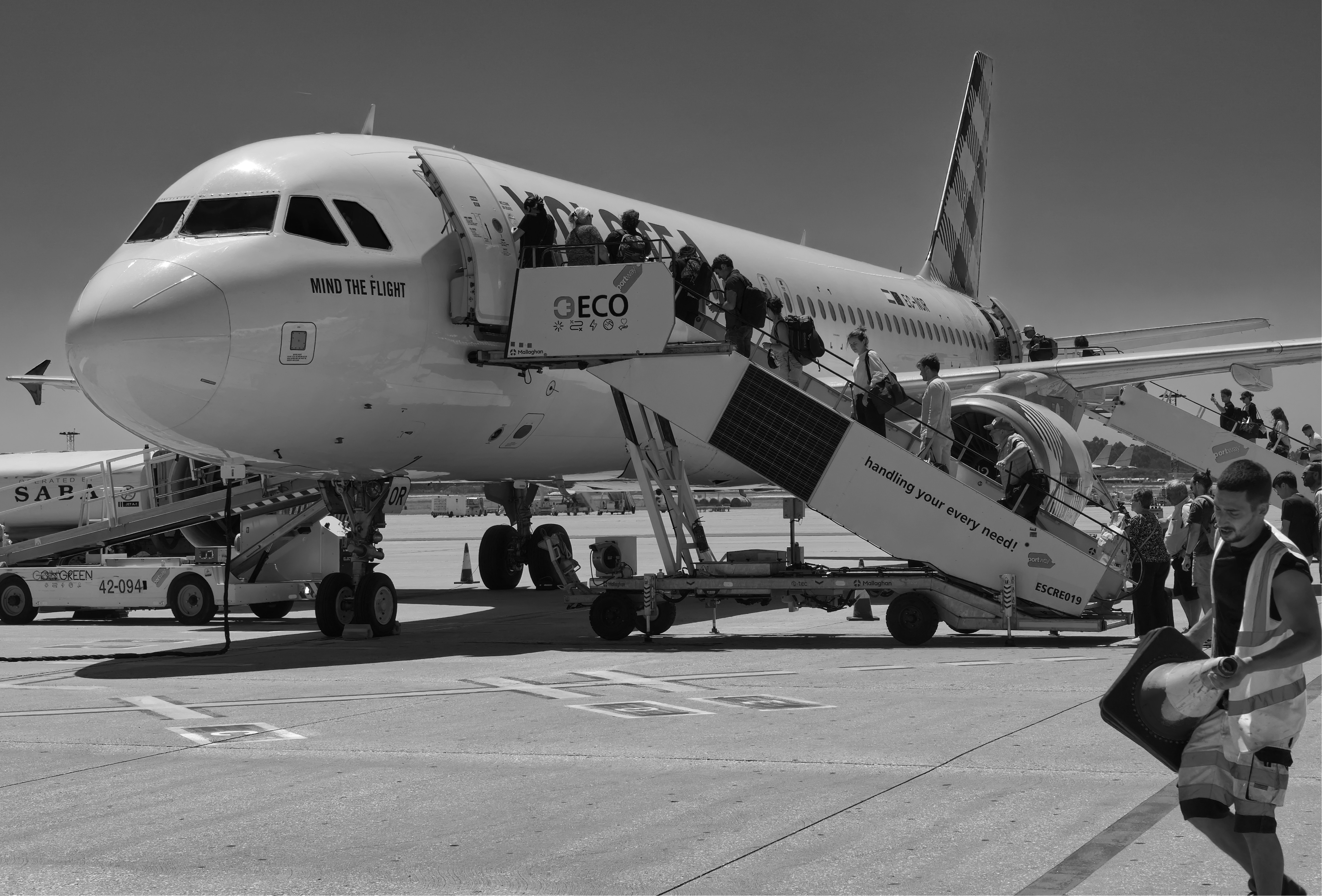 Grounded Entry: Passengers Debark from a Jet under a Clear Sky