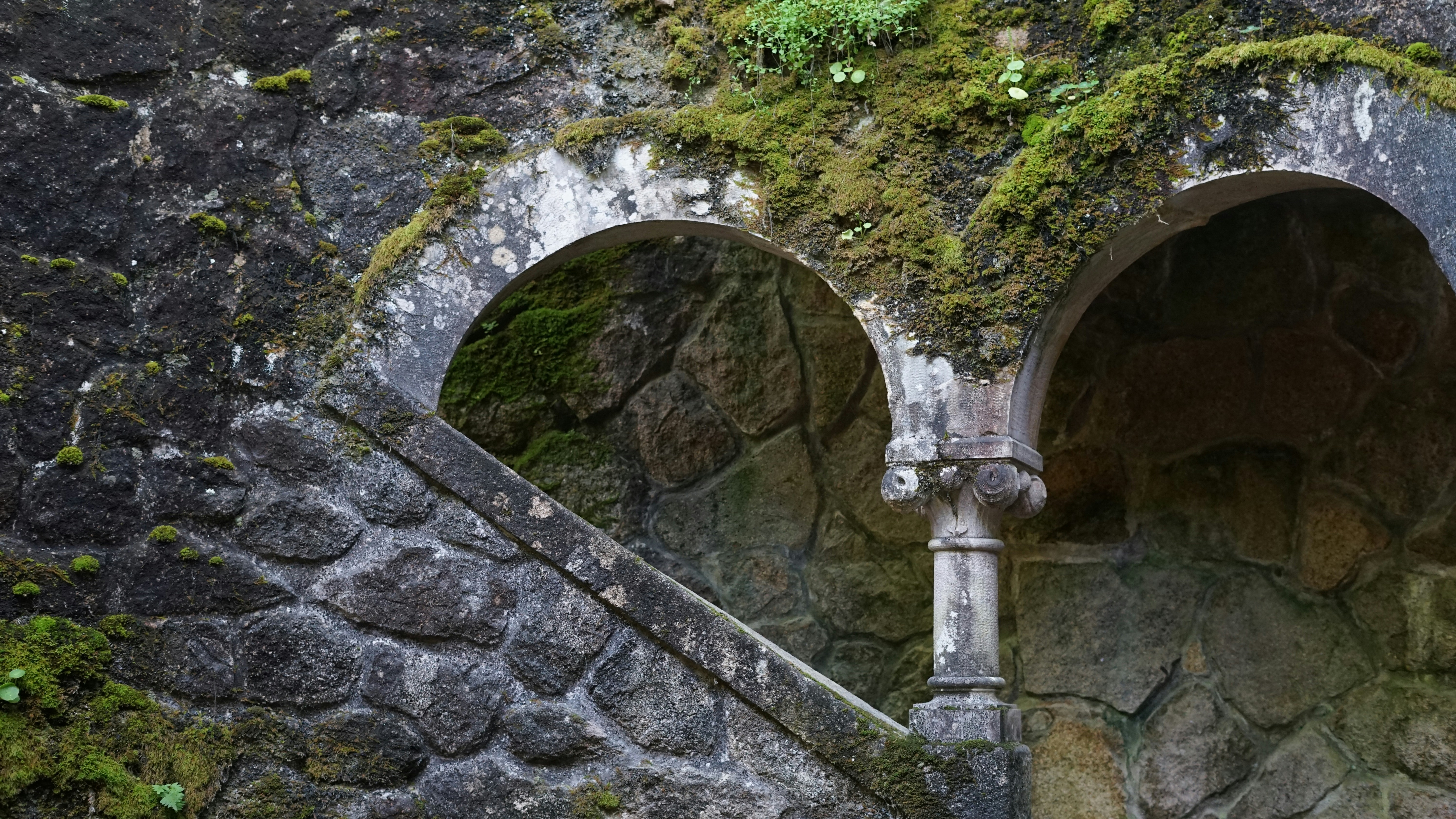 Moss-Ced Archway: Quiet Stone Corridor