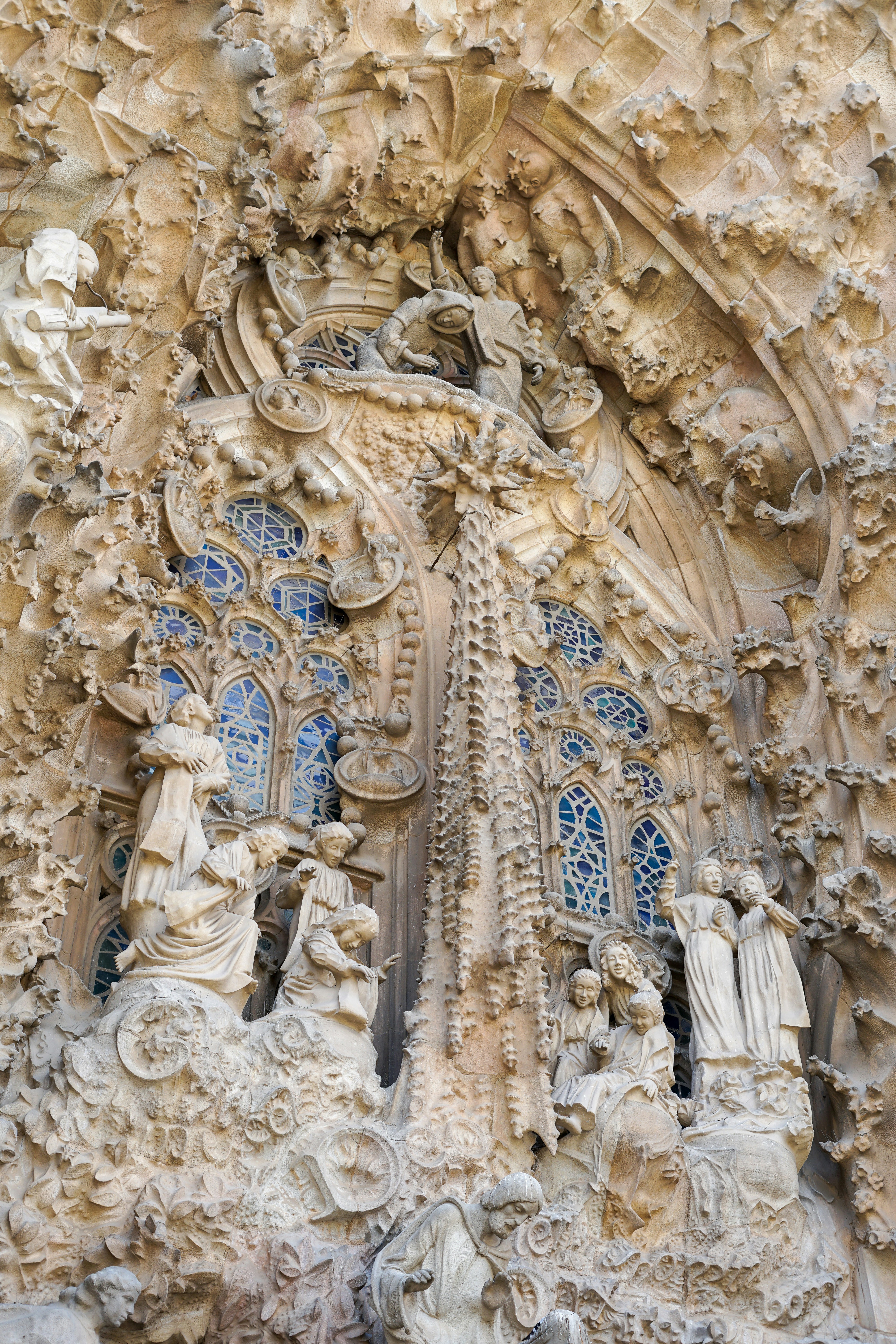 Stone Symphony: Carved Figures and Gothic Foliage on a Sacred Façade