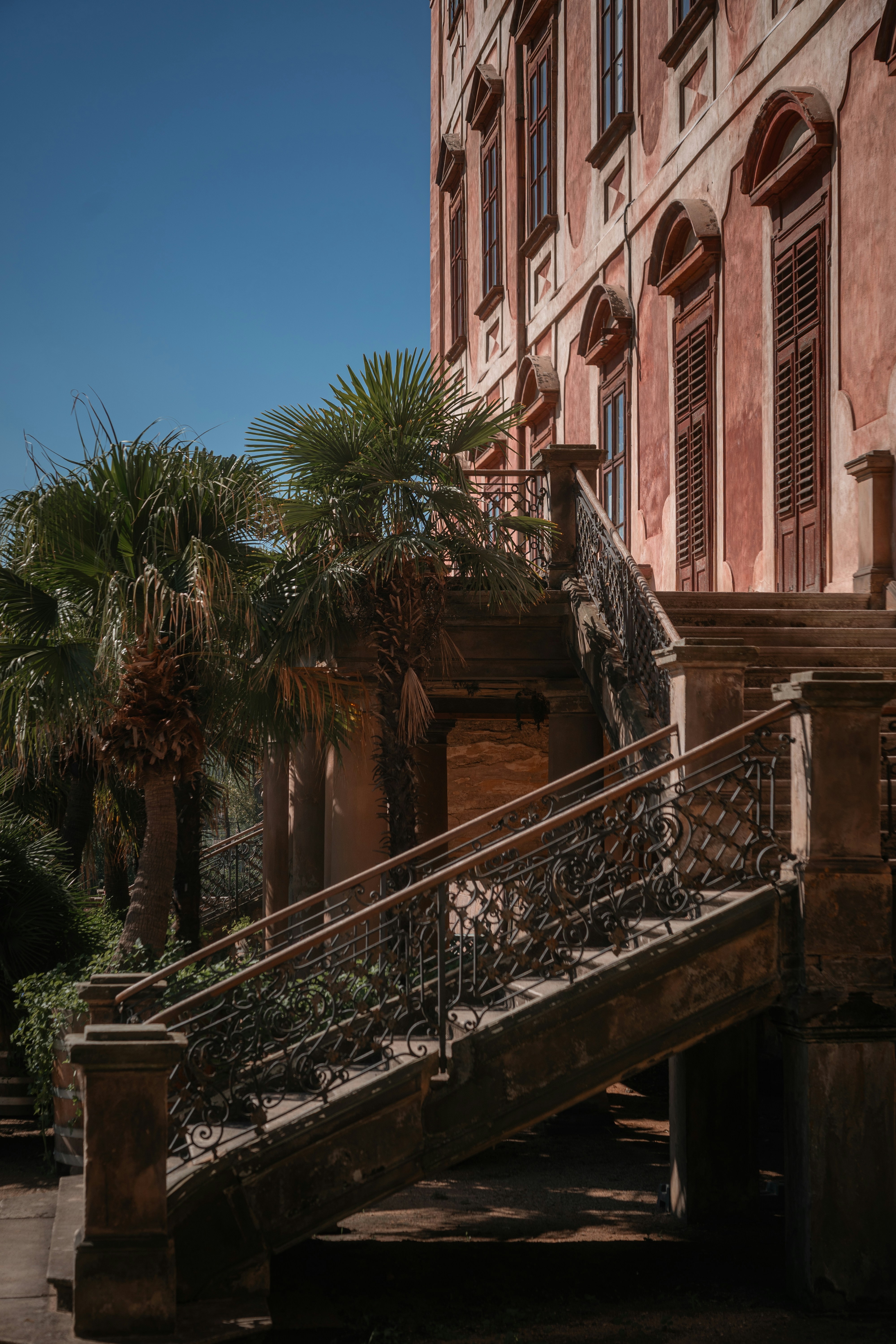 Sunlit Marble Staircase Becomes a Crimson Facade