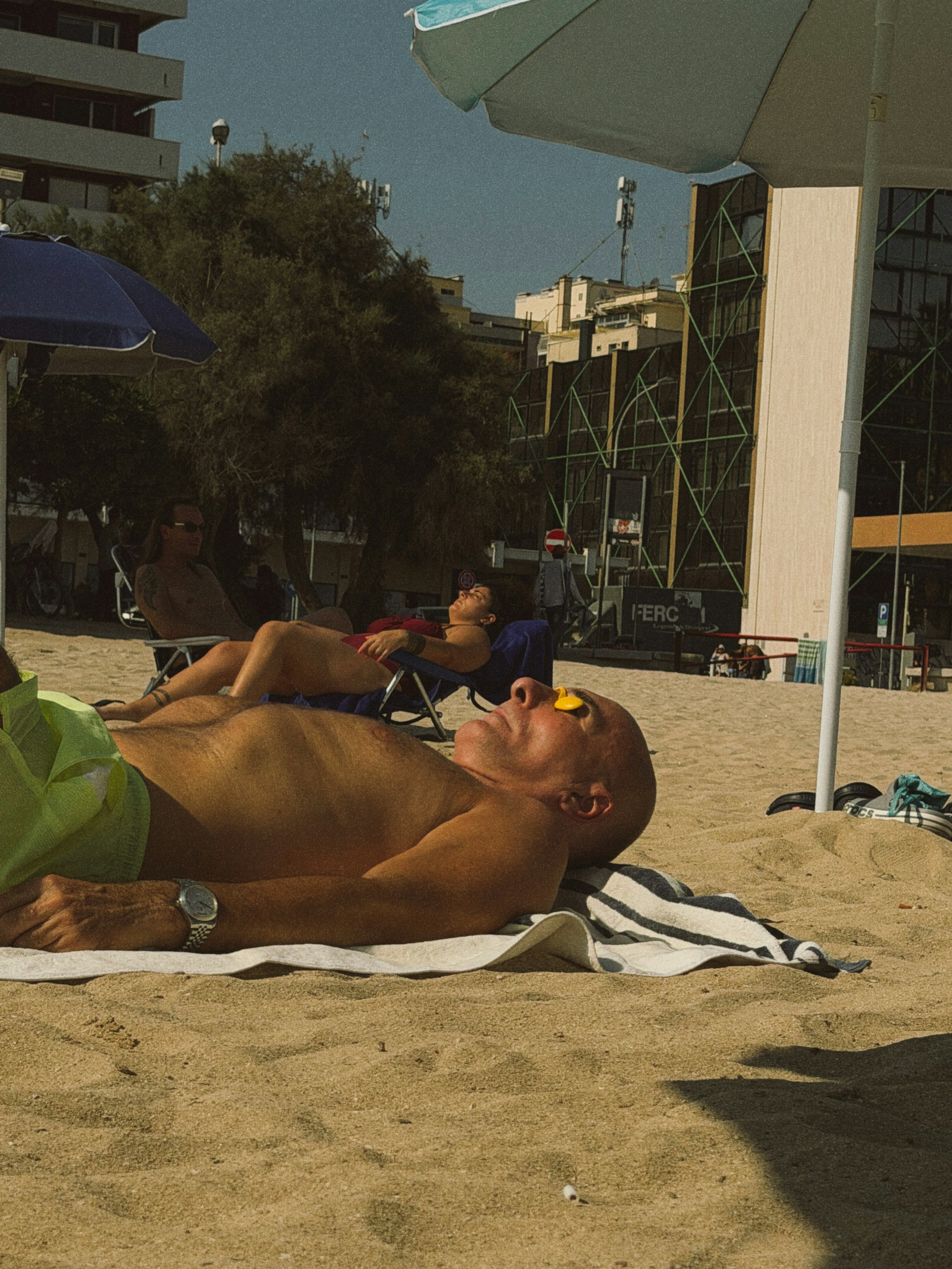 Sunlit Playa: A Man Absorbs the Shoreline Glow