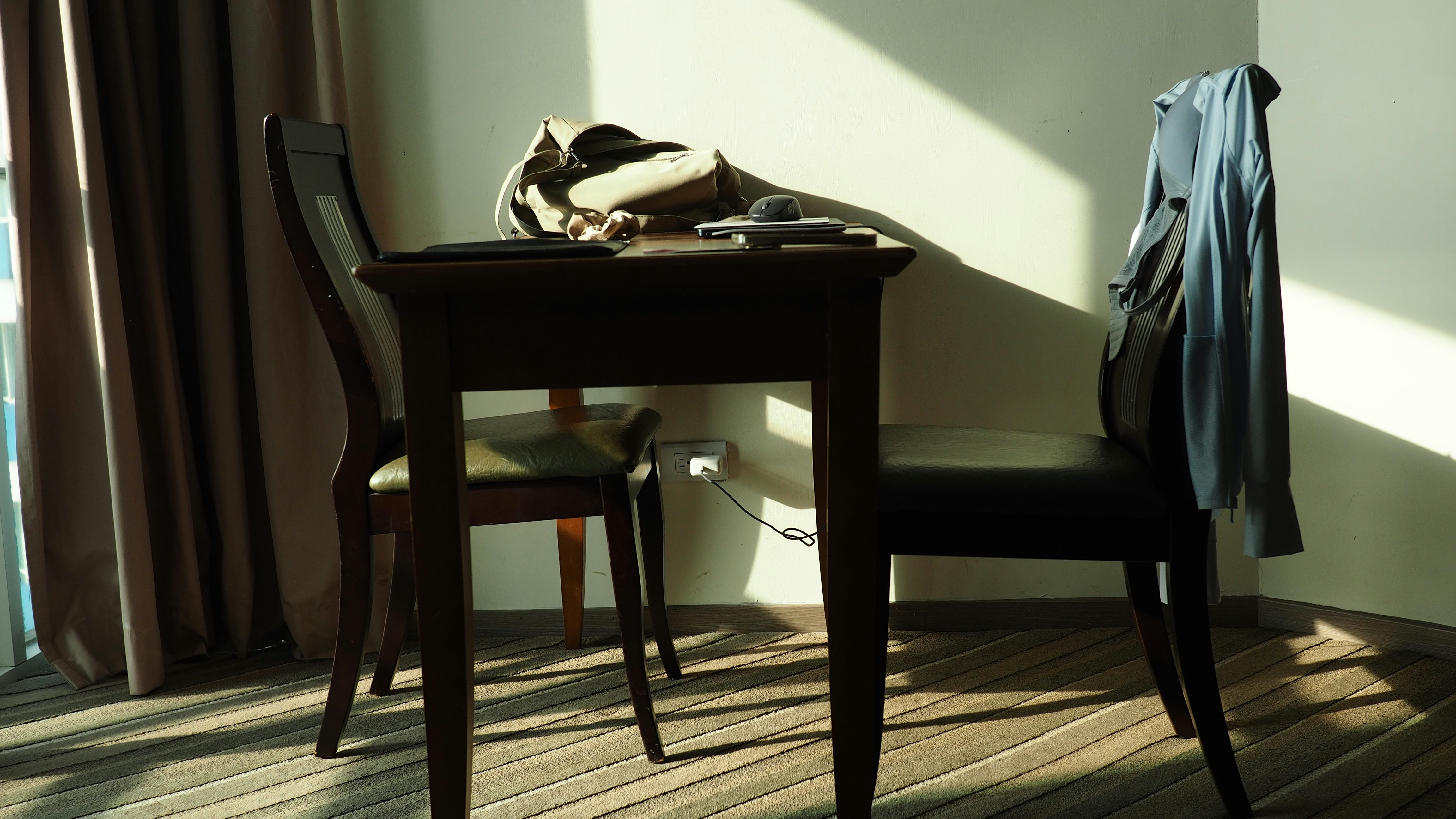 Sunlit Shoes and Jacket: A Quiet Corner of a Hotel-like Table Scene
