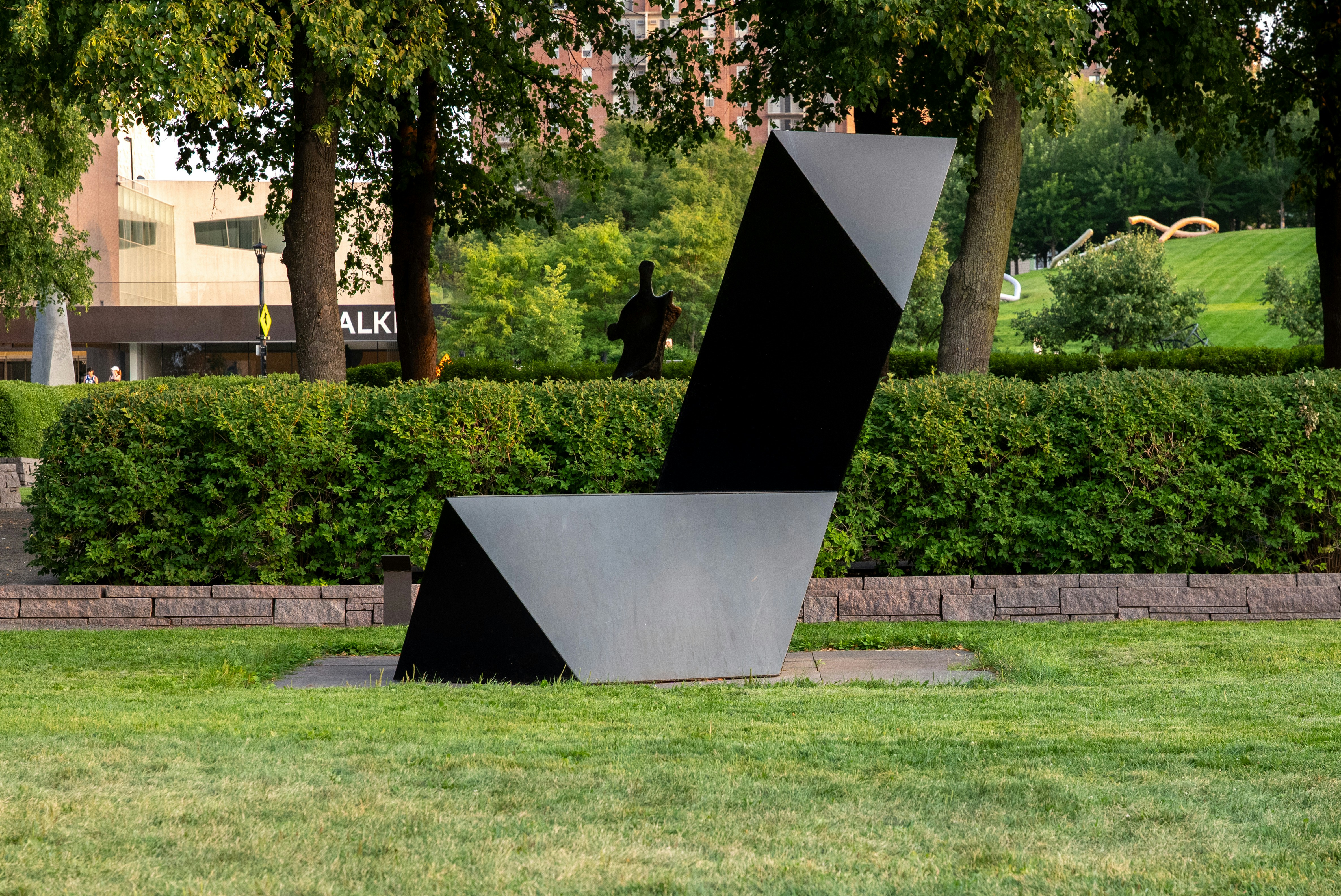 Angular Echo: A Geometric Sculpture in a Sunlit Park